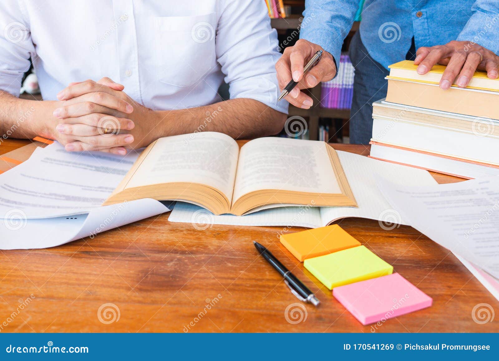 Tutor and College Students Teaching School Work and Explaining Problem ...