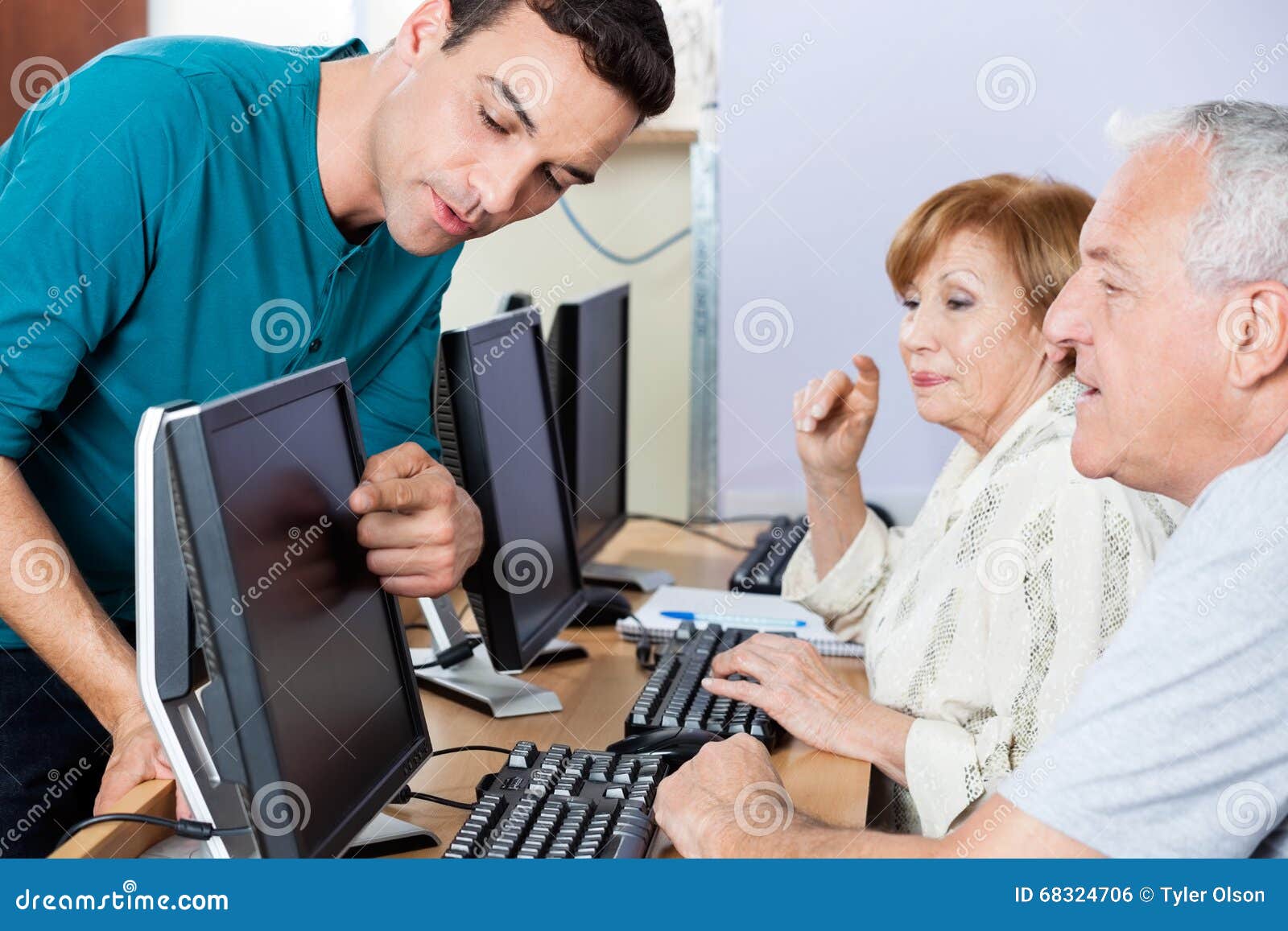Tutor Guiding Senior Students in Using Computer at Classroom Stock ...