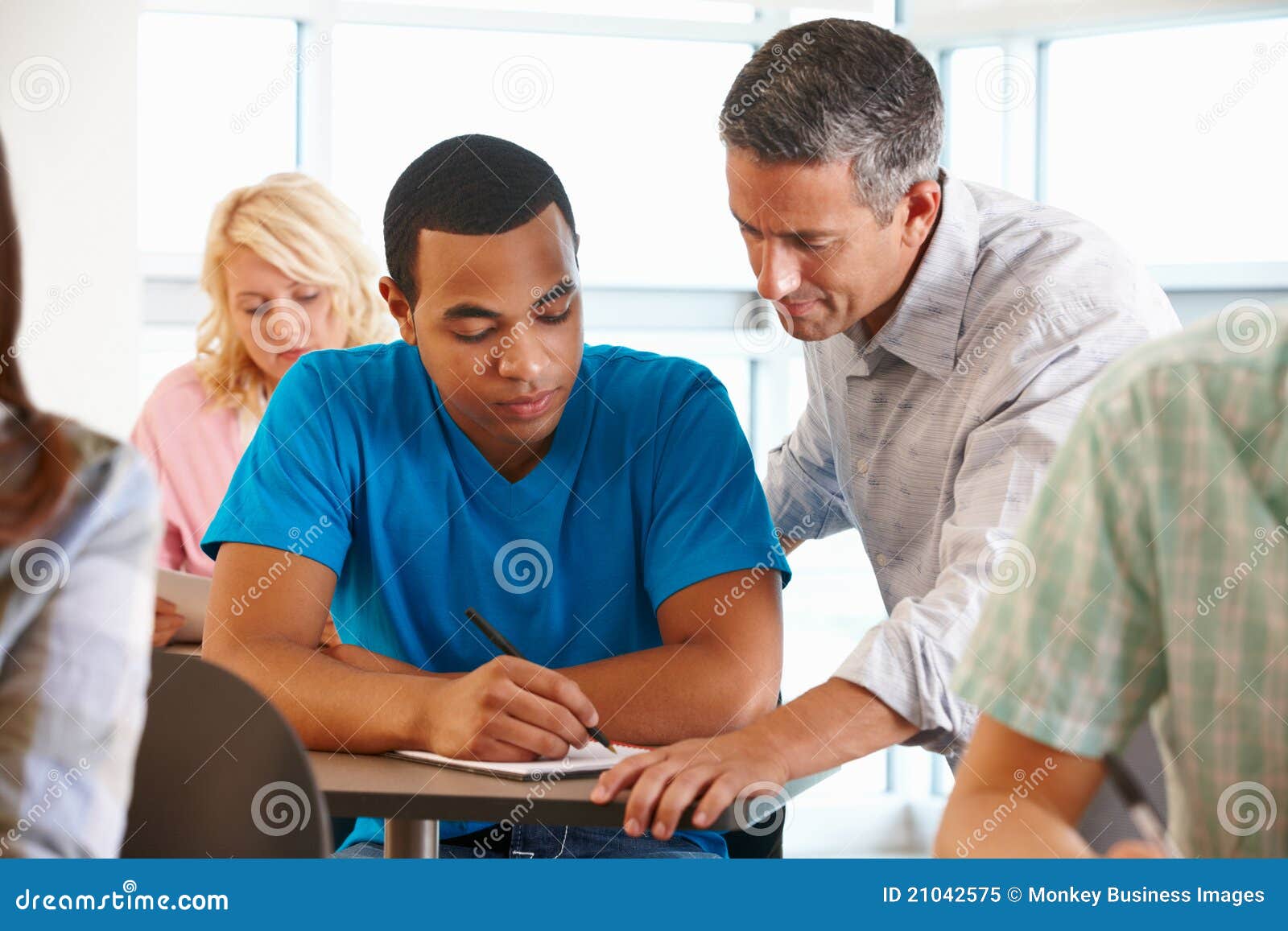 Tutor Helping Student in Class Stock Image - Image of portrait, group ...