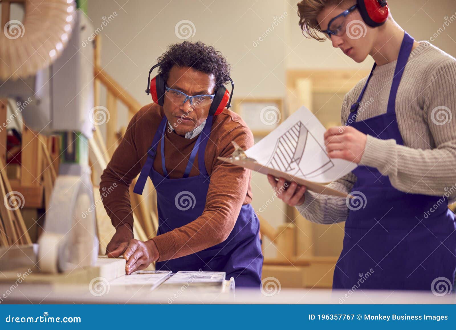 Tutor with Male Carpentry Student in Workshop Studying for ...