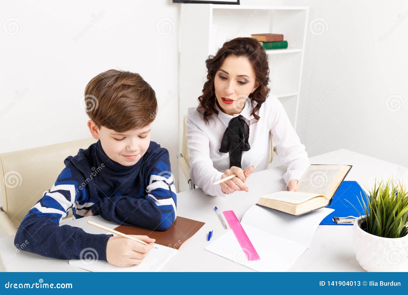 Tutor and Student Sitting in the White Room and Doing Tasks for Lessons ...