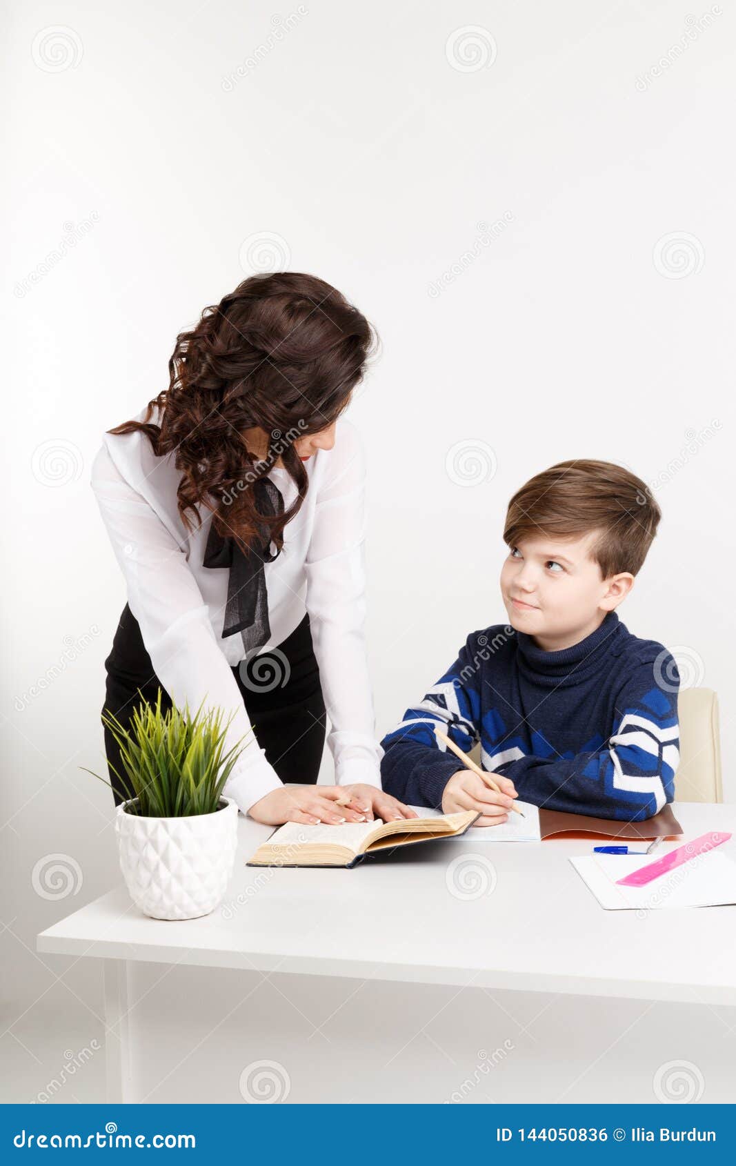 Tutor and Student Sitting in the White Room and Doing Tasks for Stock ...