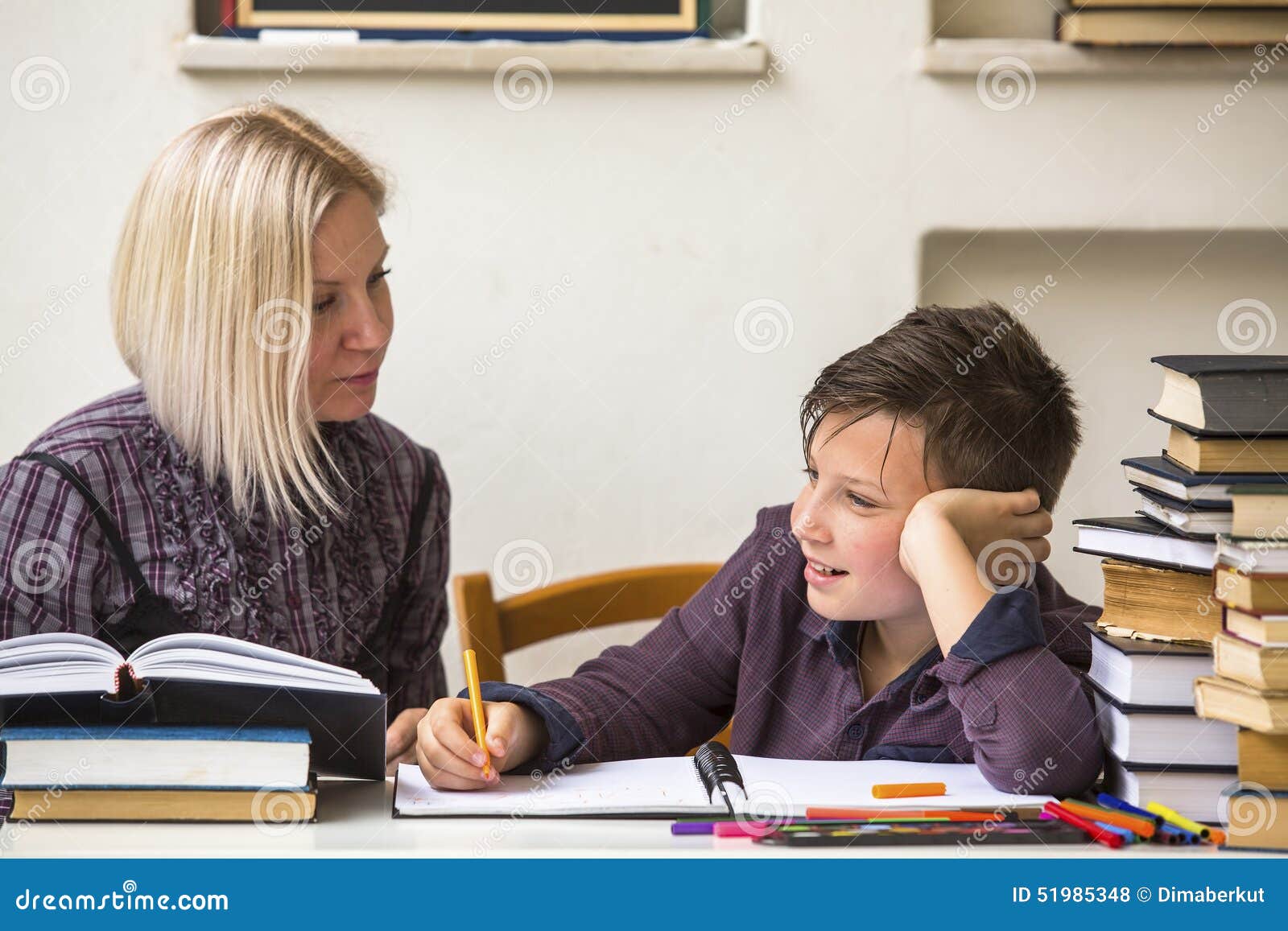 Tutor Teaches a Young Student with His Studies. Education. Stock Photo ...