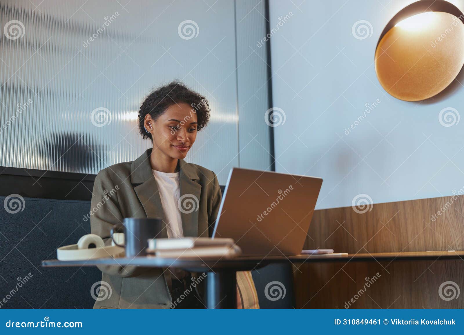 TV Presenter Using Laptop at Table in Building Event, with Fun Display ...