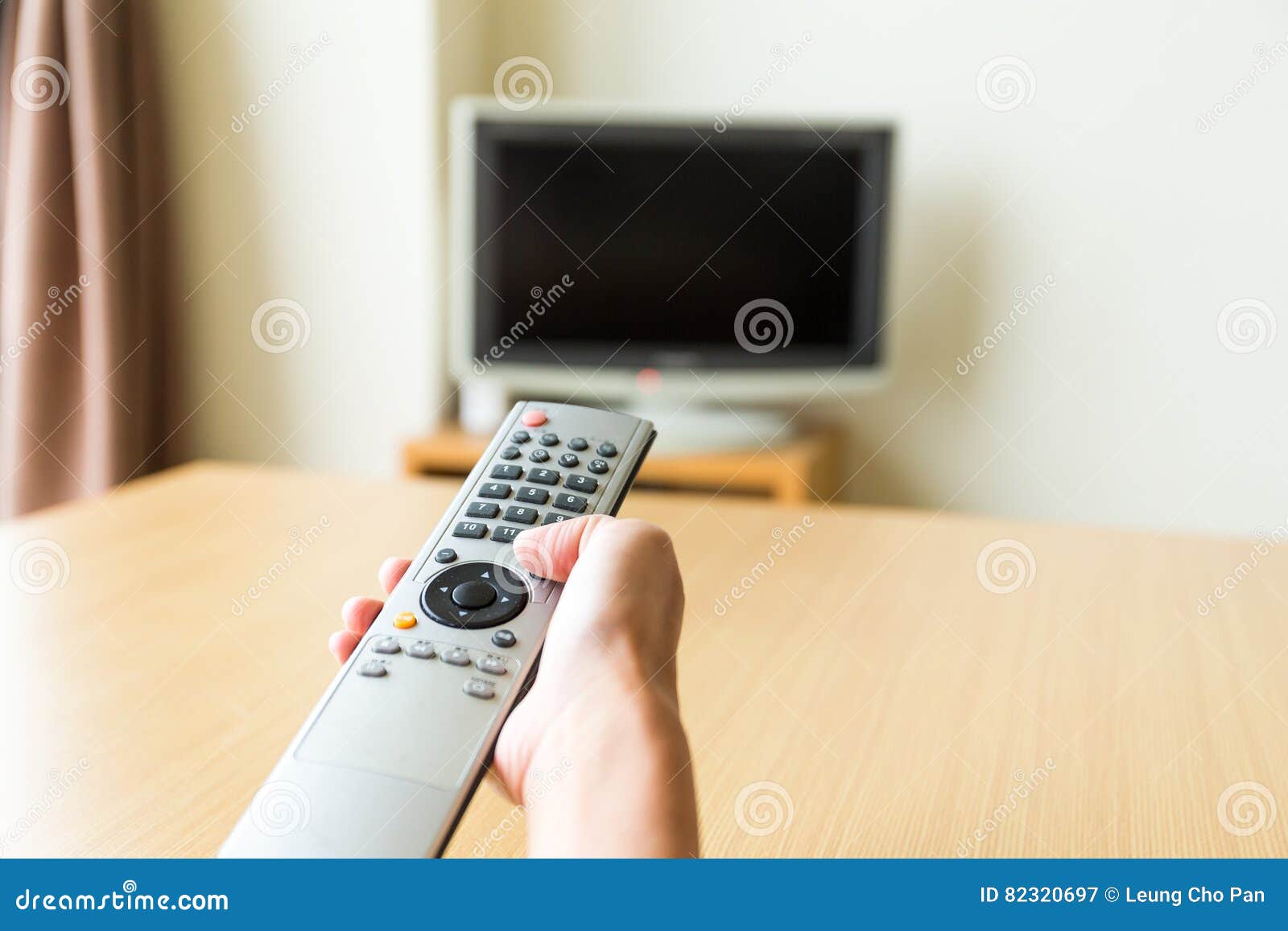 TV remote control in hand stock image. Image of display - 82320697