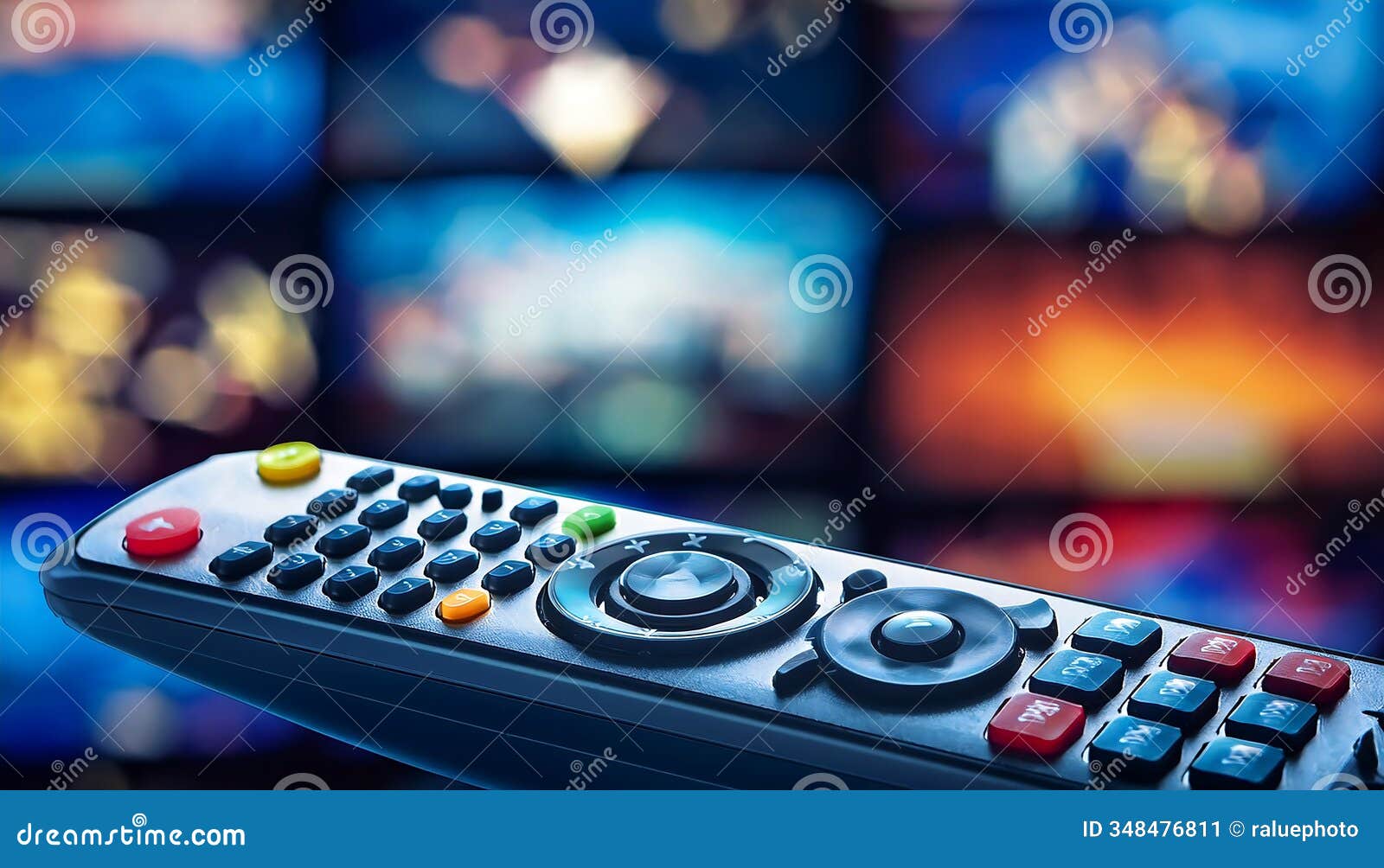 A TV Remote Control Many Channels are Visible in the Background Stock ...