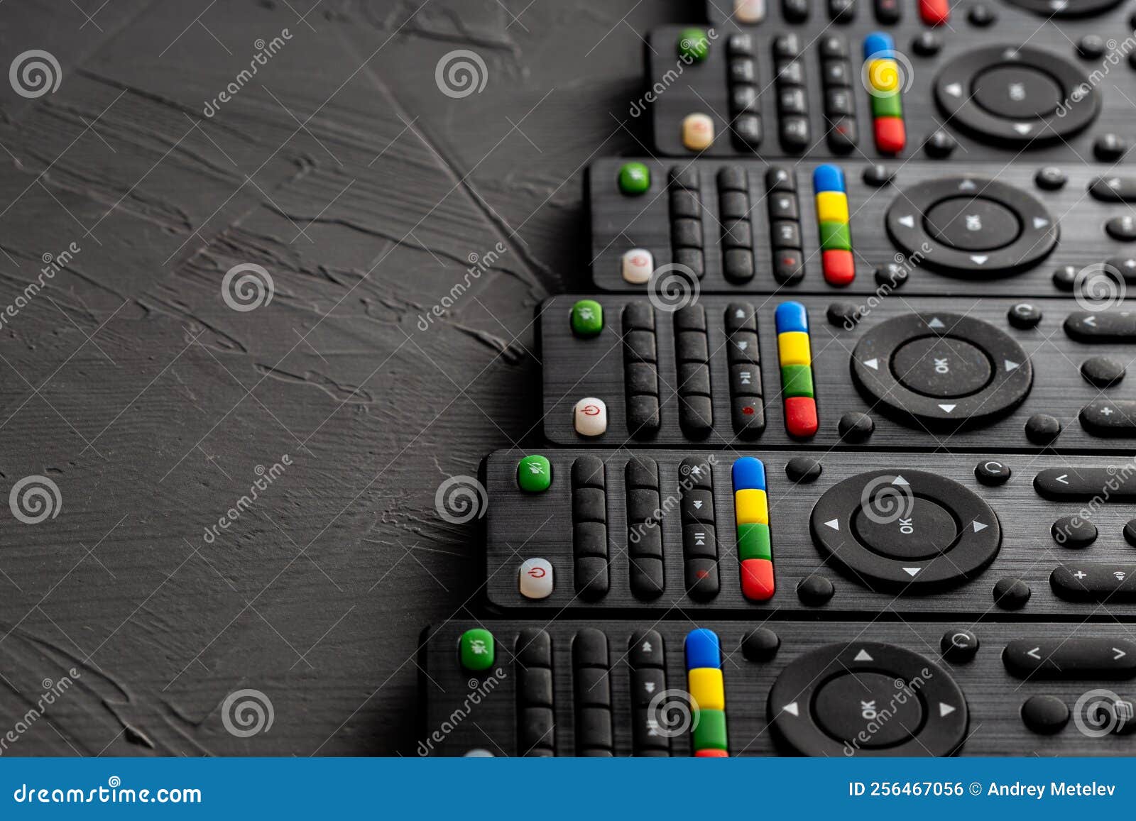 TV Remotes are Stacked in a Row on a Dark Background Stock Photo ...