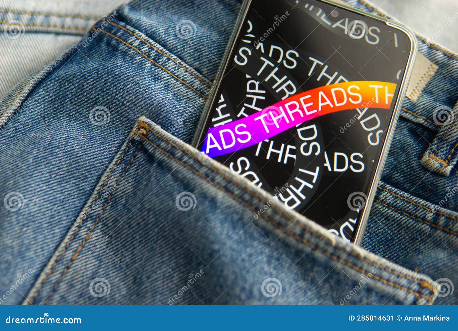 Tver, Russia - July 15, 2023, the Threads Logo on the Smartphone Screen Lying on the Jeans. the ...