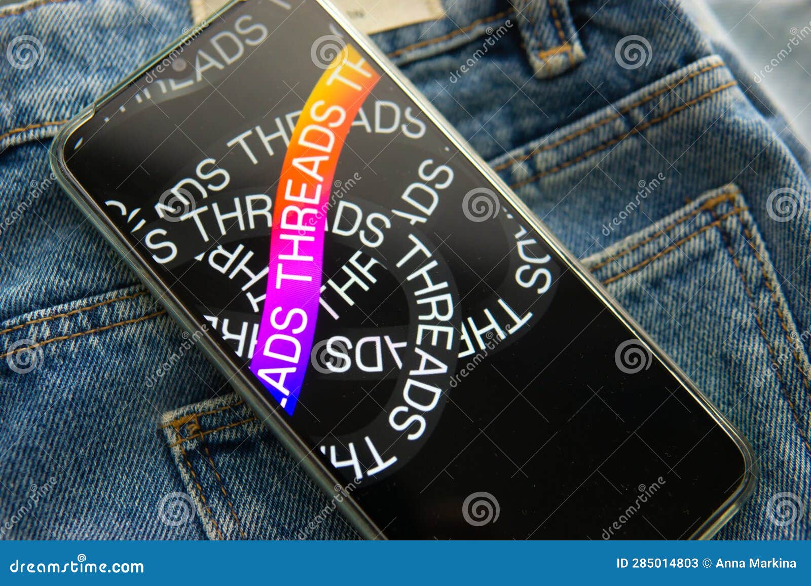 Tver, Russia - July 15, 2023, the Threads Logo on the Smartphone Screen Lying on the Jeans. the ...