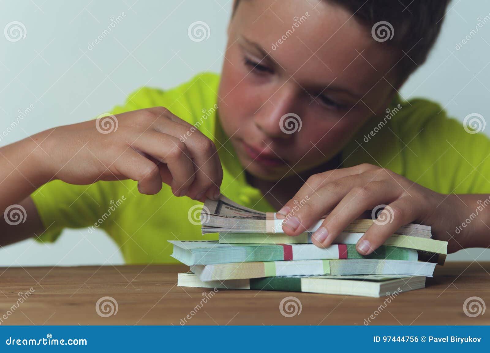 Tween Boy Sitting at the Table with Dollar Bills. Stock Photo - Image ...