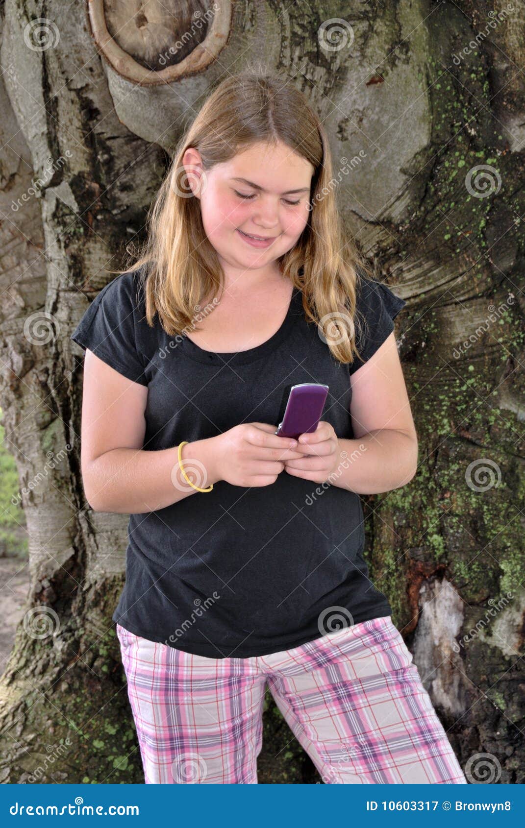 Tween Using Phone stock image. Image of child, text, tree - 10603317