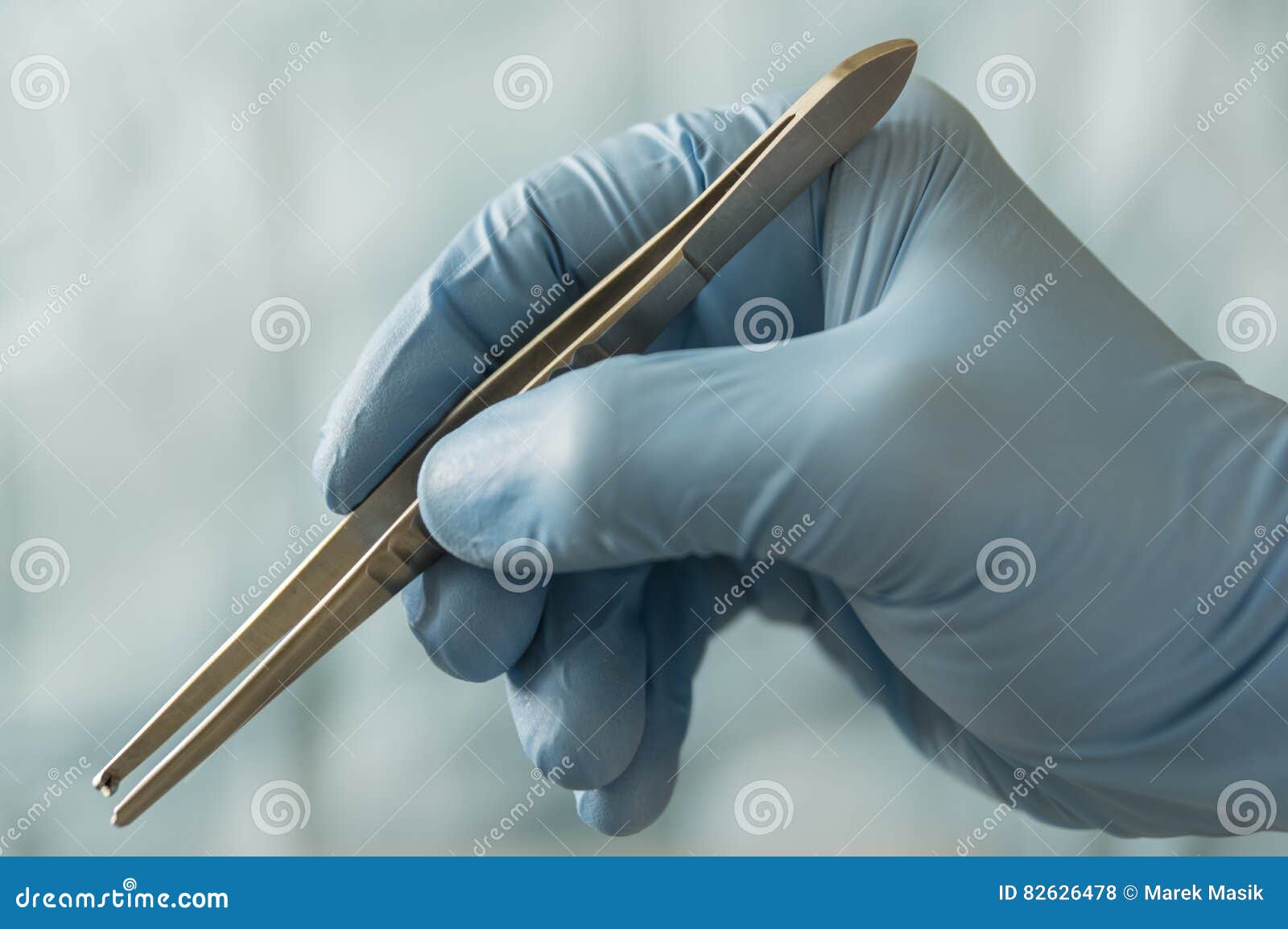 Tweezers in hand stock photo. Image of care, hospital - 82626478
