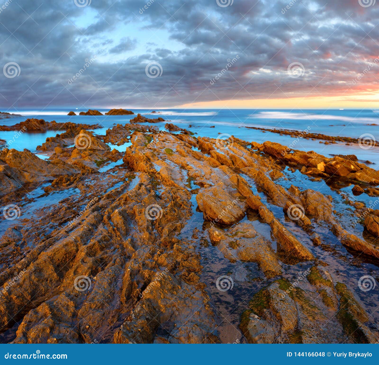Twilight Ocean Coast with Ribbed Stratiform Rock Stock Photo - Image of ...