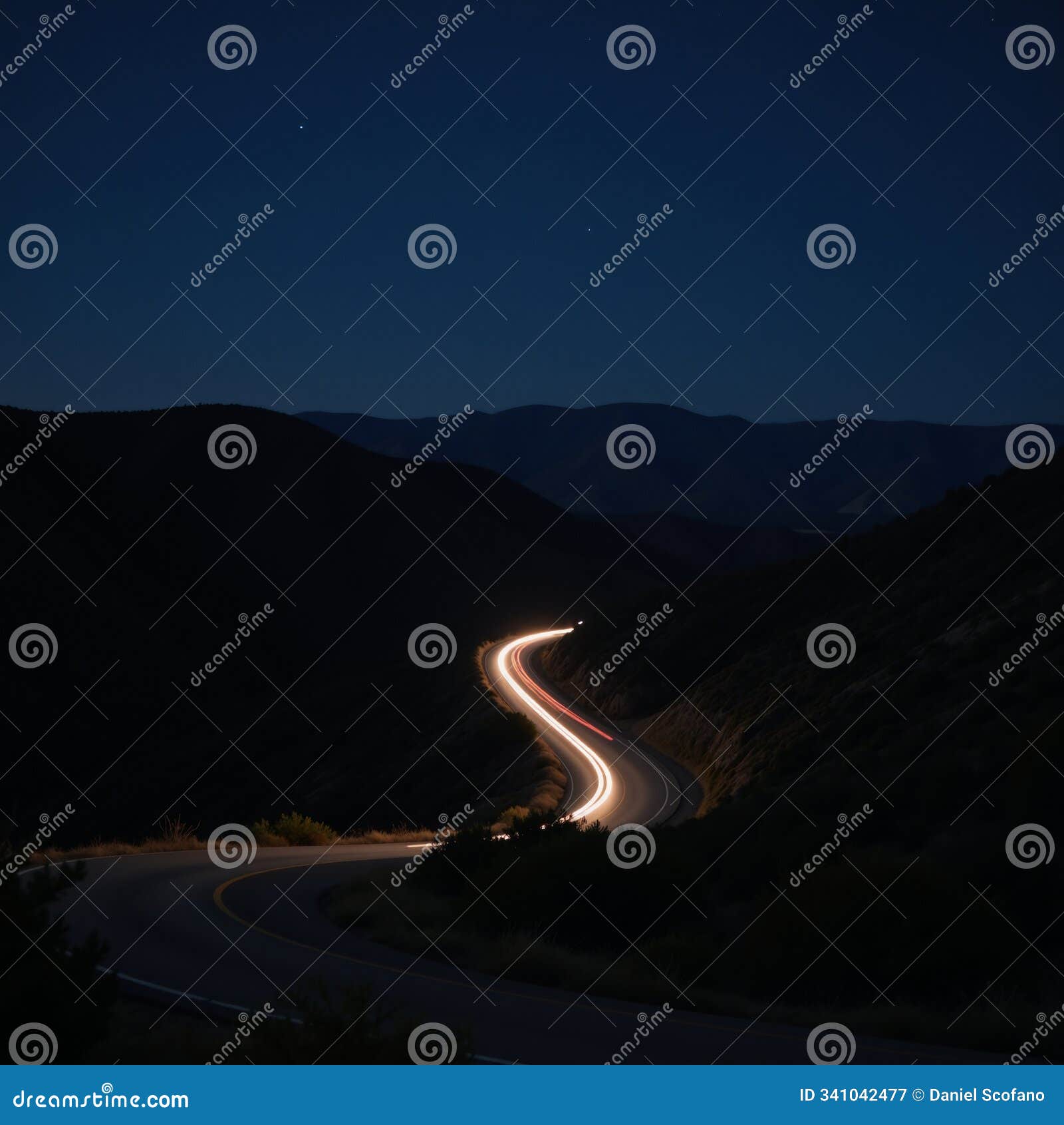 A Twilight Road with Headlightlit Curves Set Amidst a Starry Night Sky ...