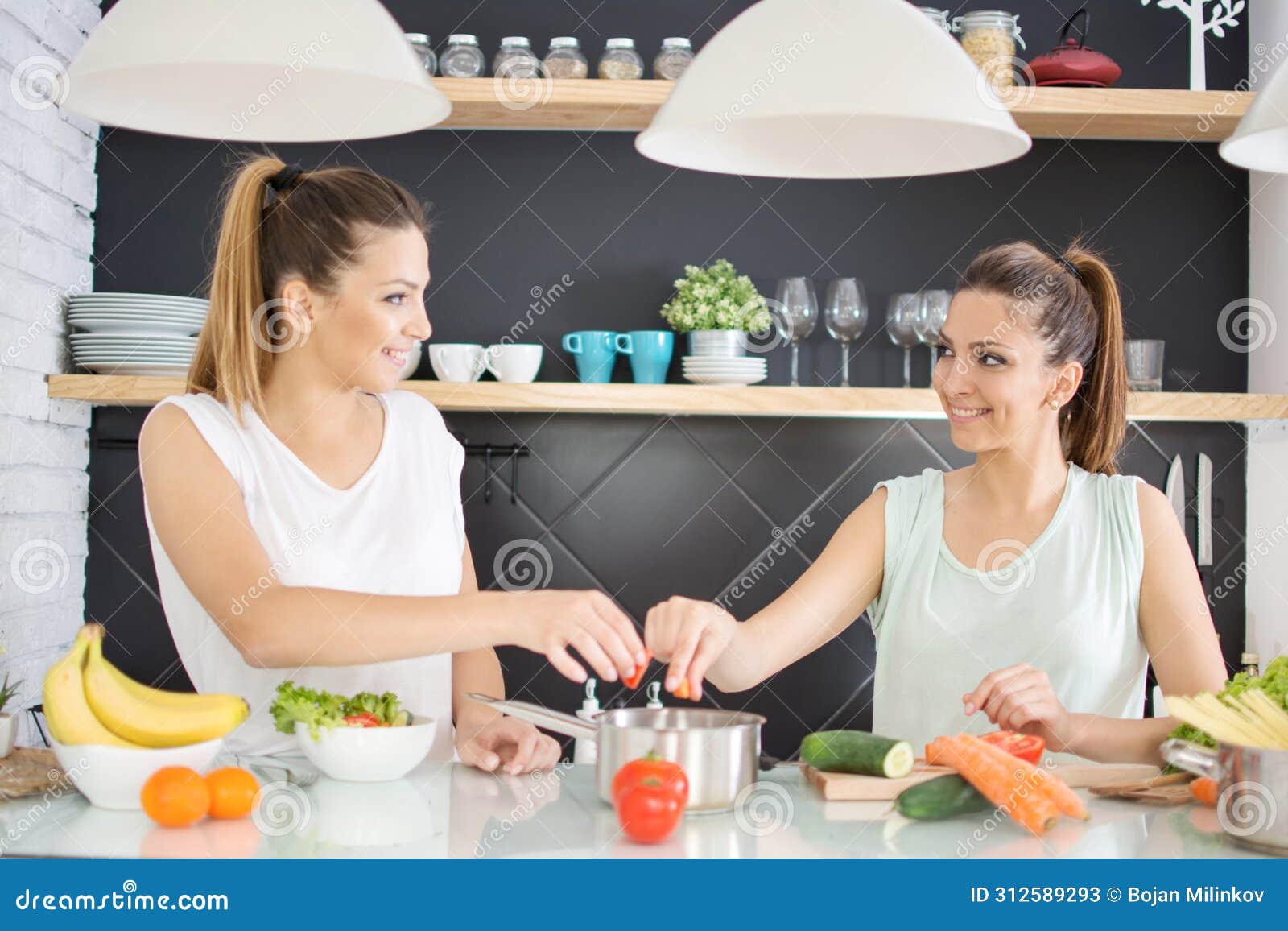 Twin Sisters Preparing Healthy Food in the Kitchen. Stock Image - Image of dinner, women: 312589293