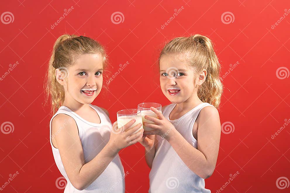 Twins drinking milk smile stock image. Image of childhood - 2250145