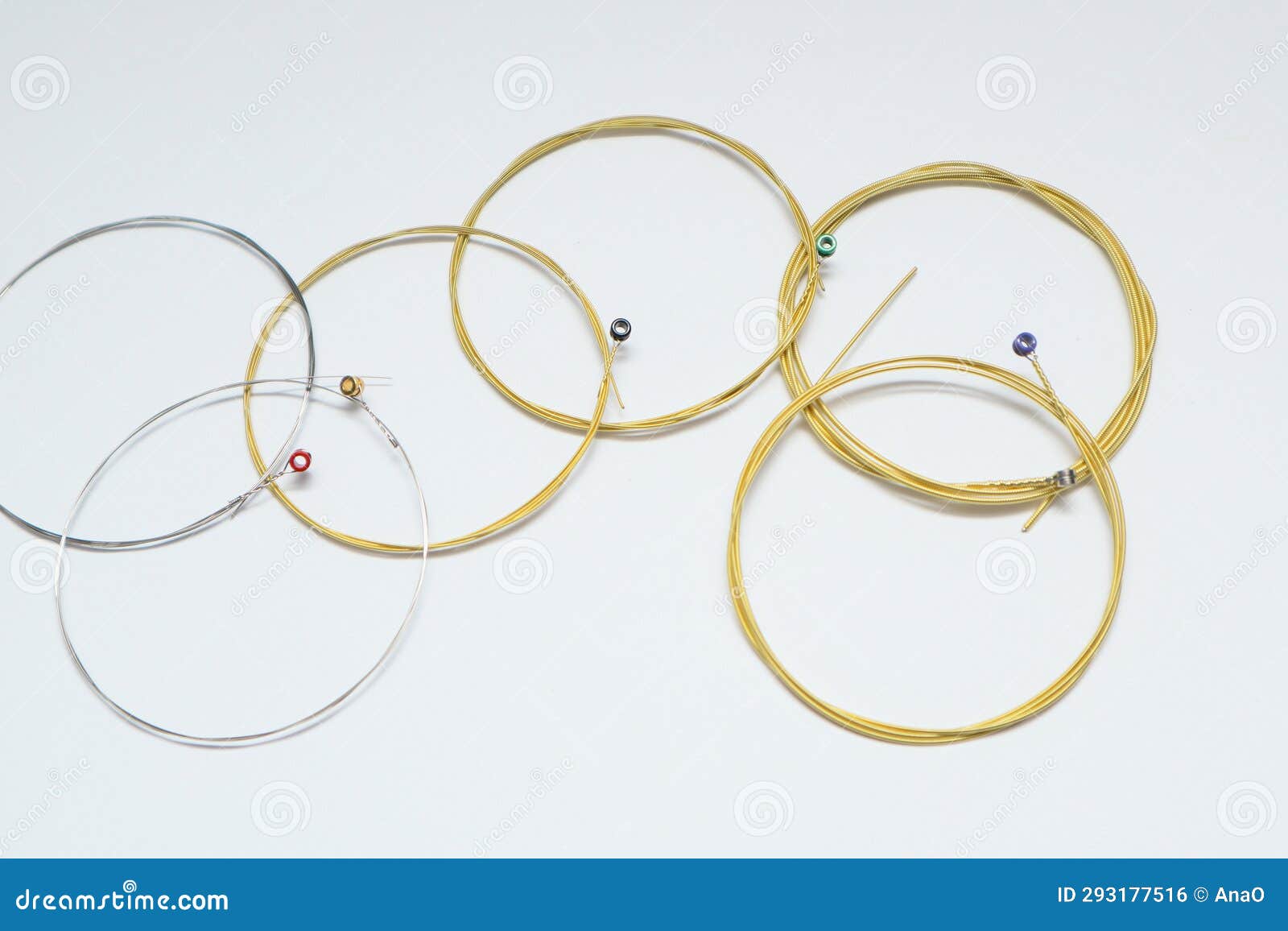 Twisted New Guitar Strings on White Background. New Acoustic Guitar ...
