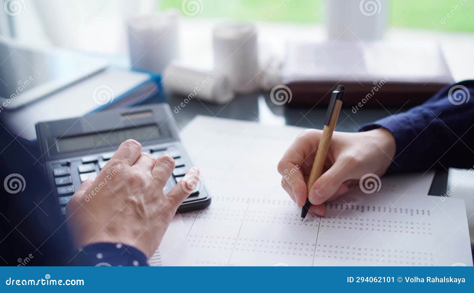 Two Accountants Dressed in Blue are Using Calculator for Counting Taxes ...
