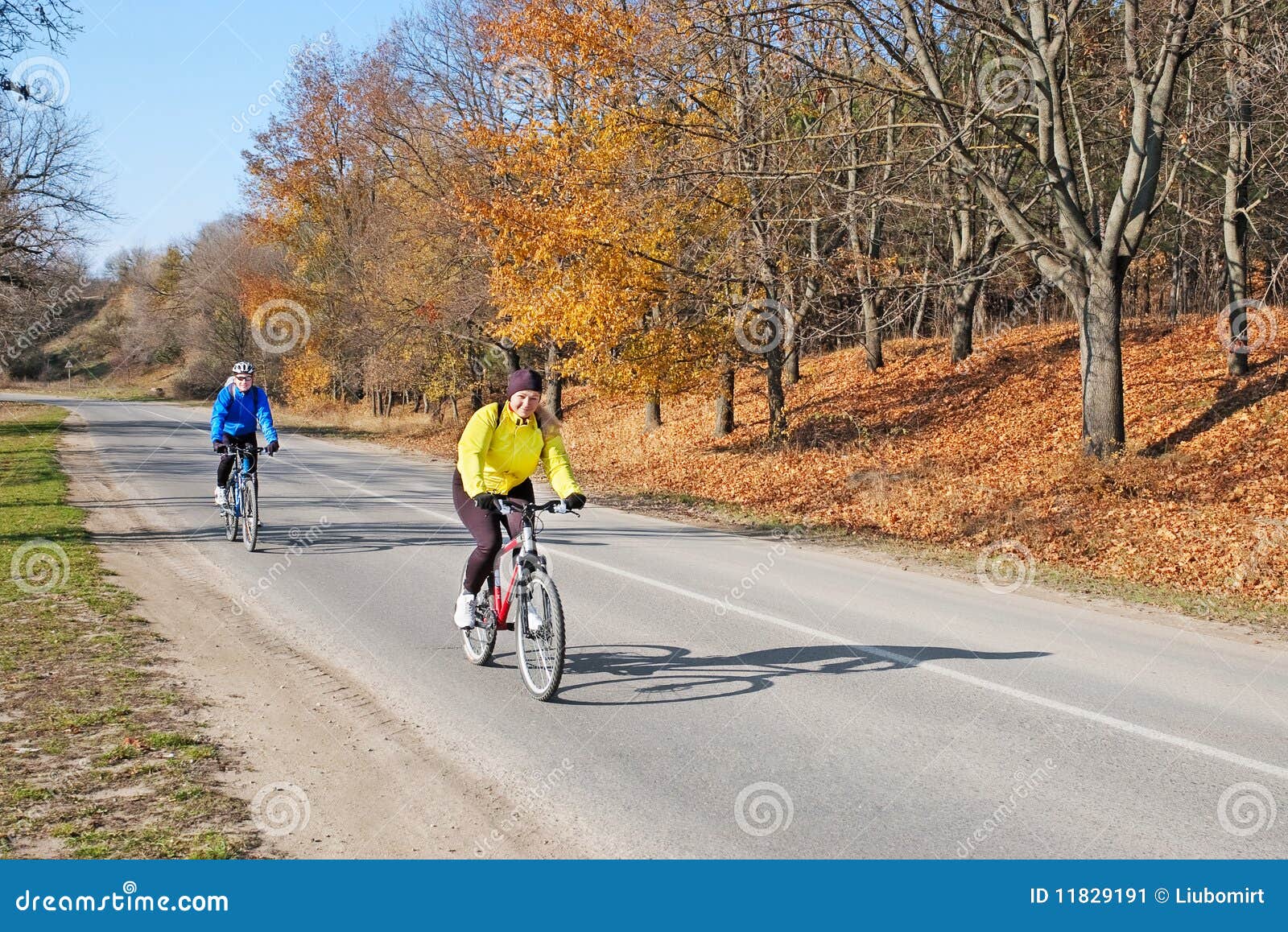 Two adults riding bikes stock image. Image of exploring - 11829191