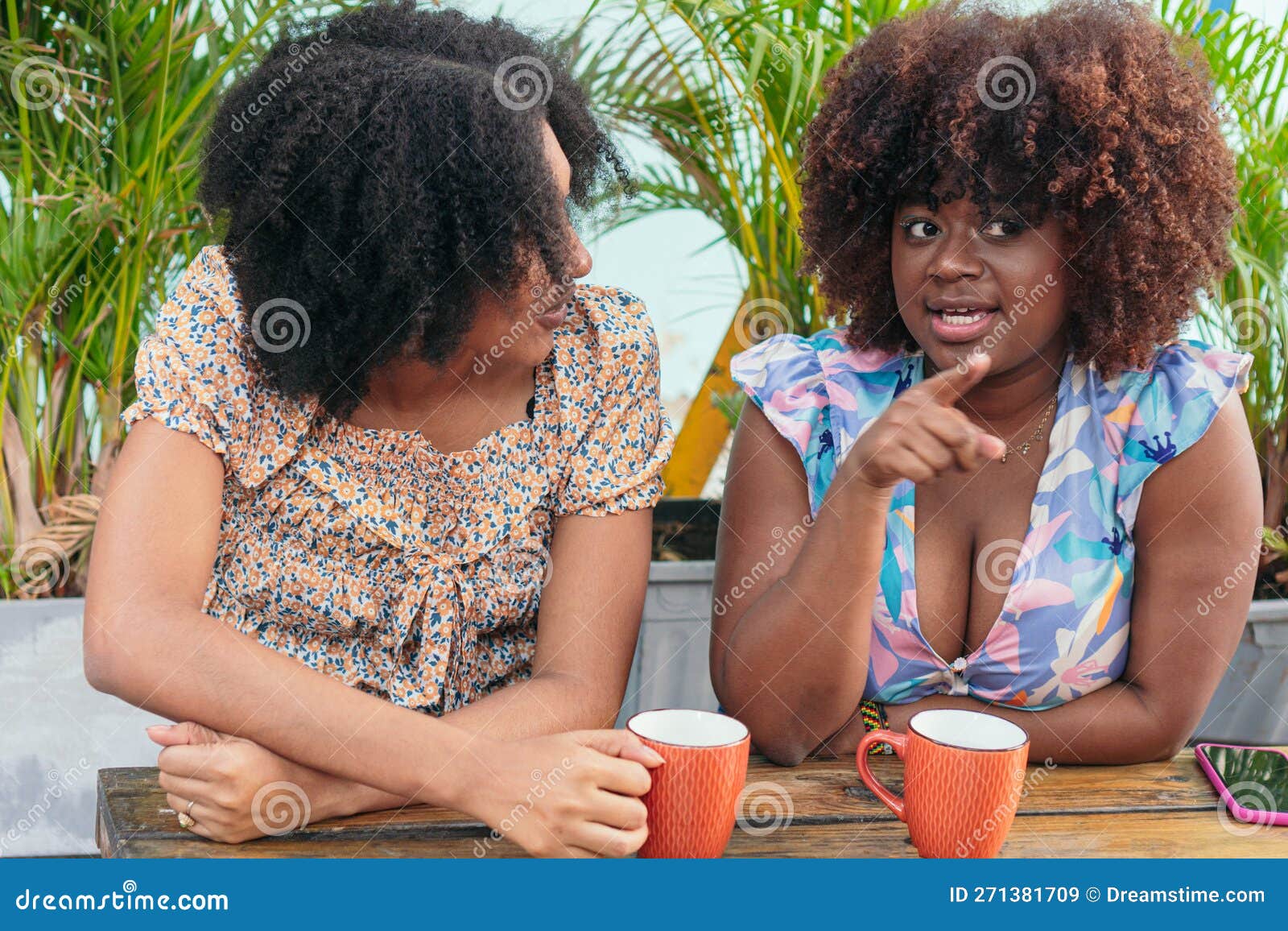 Two Afro Women Drinking Coffee Seated in a Restaurant Stock Image ...