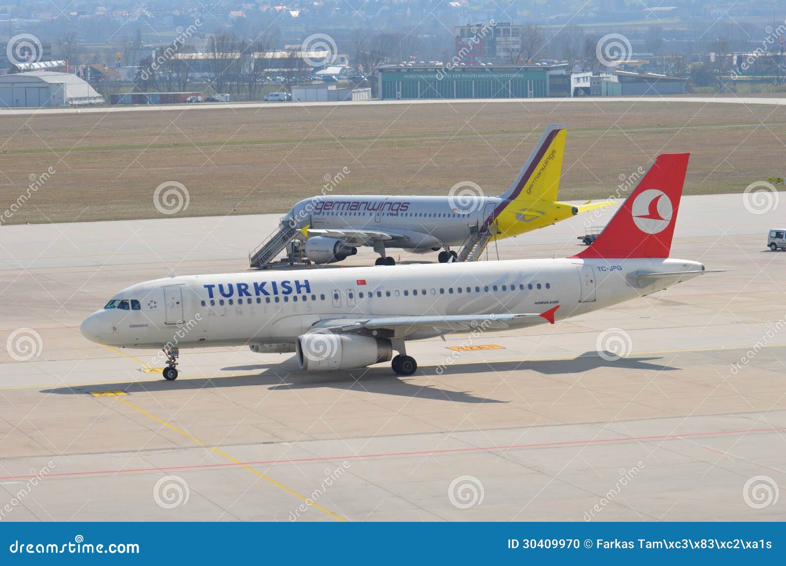 Two aircraft in runway editorial image. Image of a320 - 30409970