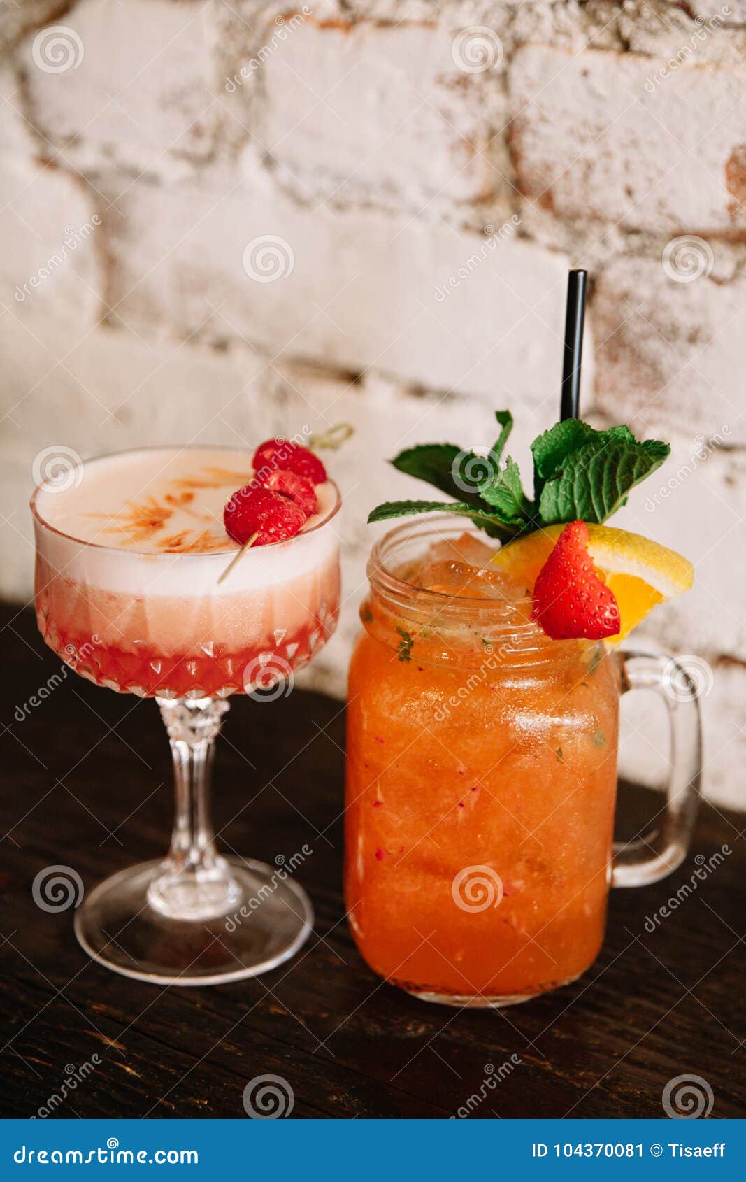 Two Alcoholic Cocktails Garnished with Berries Against the White Stock ... Two Alcoholic Cocktails Garnished with Berries Against the White Stock ...
