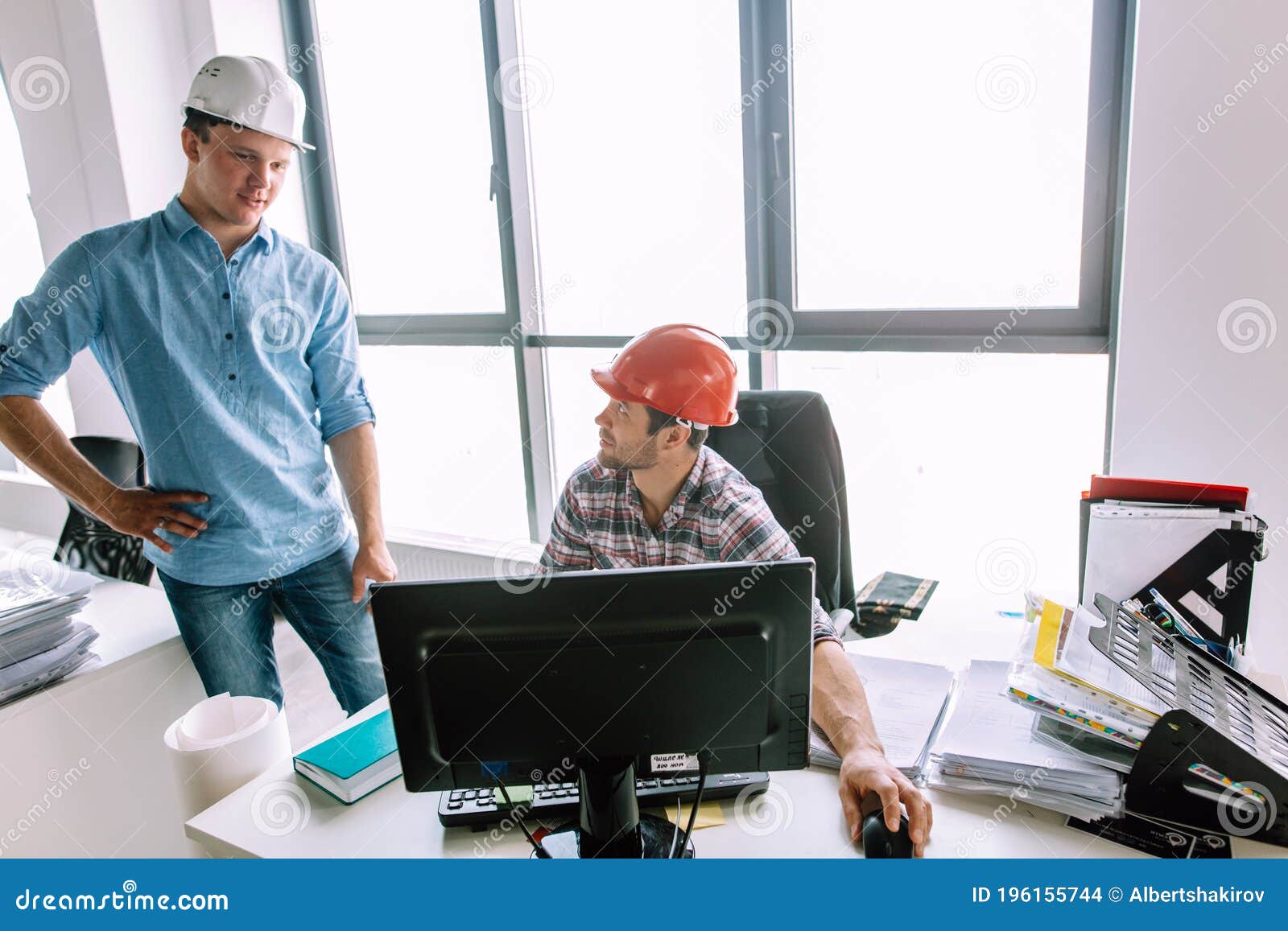 Two Ambitious Construcors are Studing the Project from the Computer ...