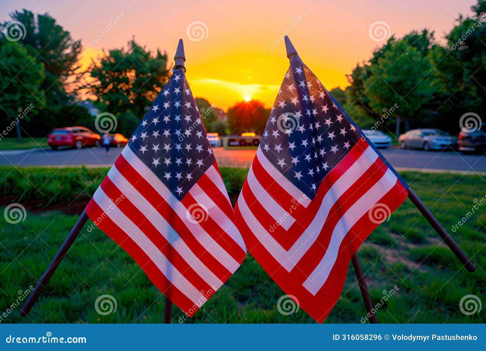 Two American Flags are Shown in Front of a Sunset Stock Photo - Image ...