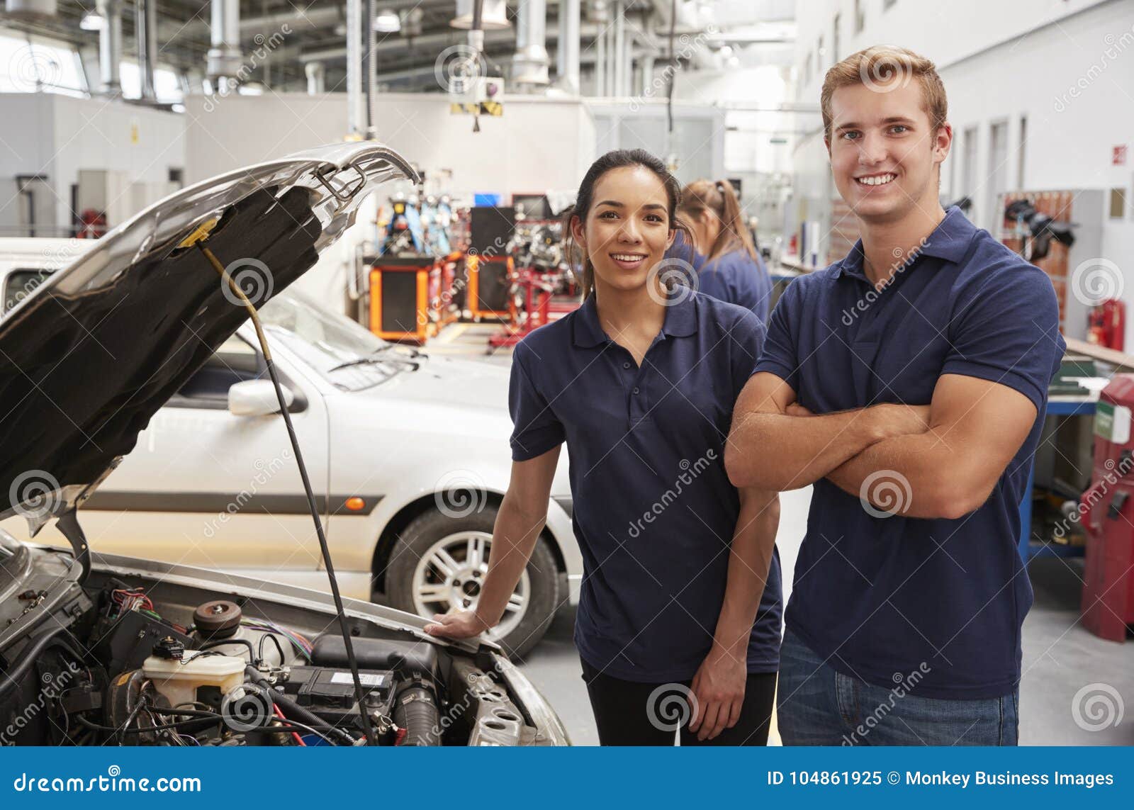 Two Apprentice Mechanics Looking To Camera beside a Car Stock Image ...
