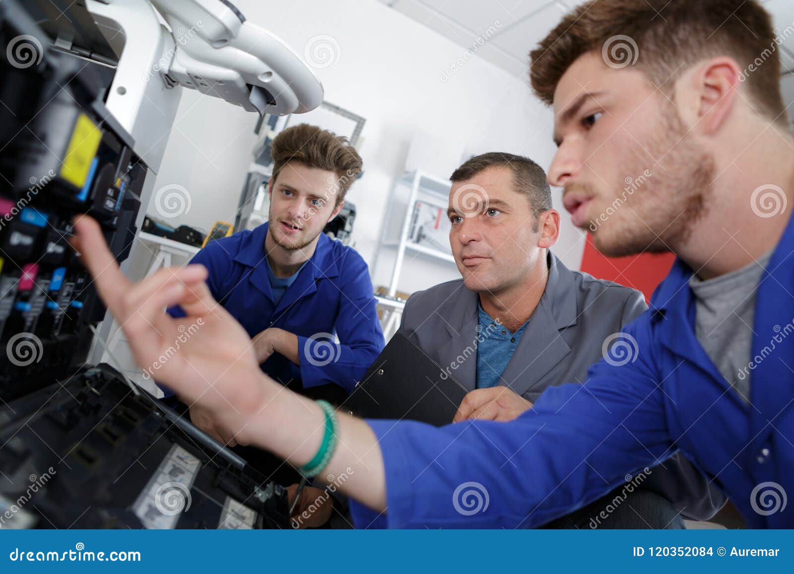 Two Apprentices and Teacher Working on Printer Stock Photo - Image of ...
