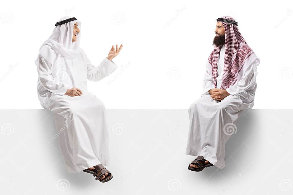 Two Arab Men Seated on a White Panel Having a Conversation Stock Photo ...