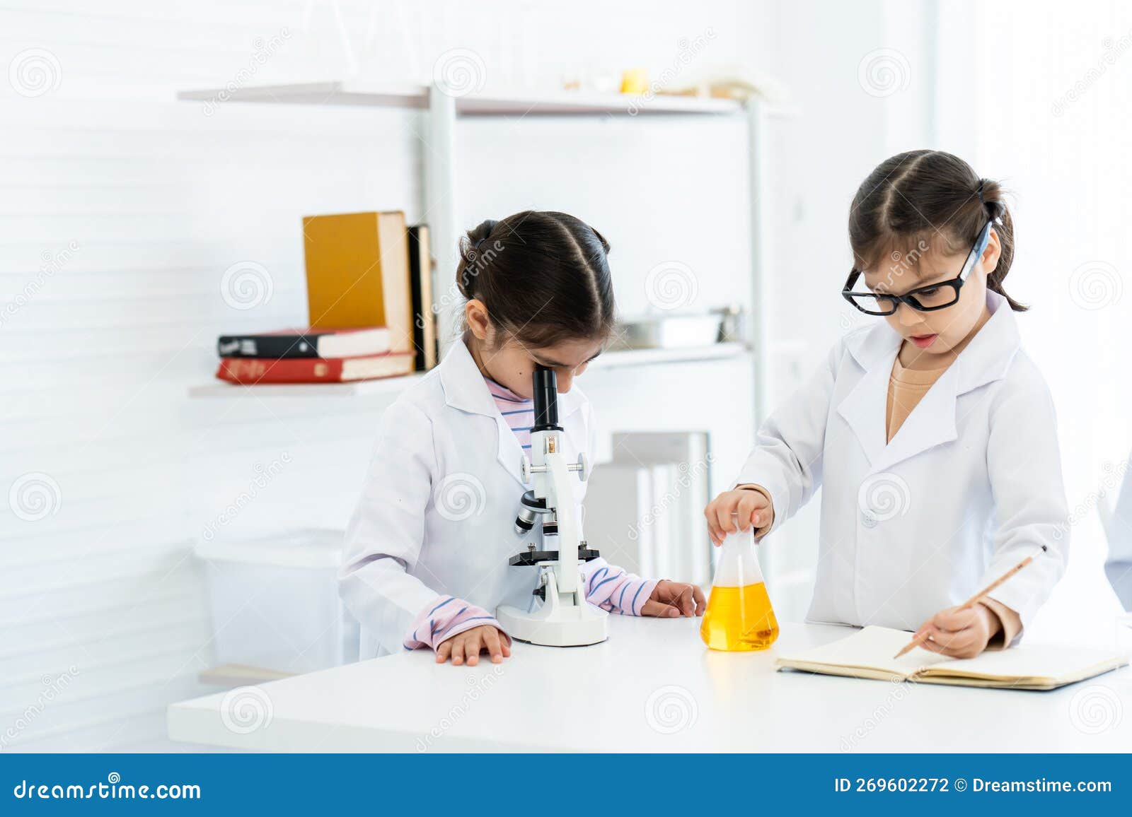 Two Arab Schoolgirls Having Fun Learning Science with the Practice of ...