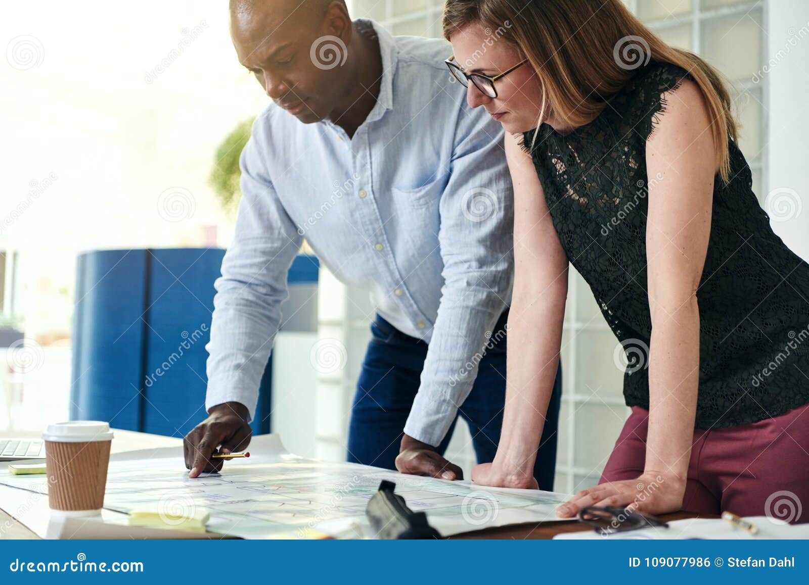 Two Architects Discussing a Building Design in an Office Stock Photo ...