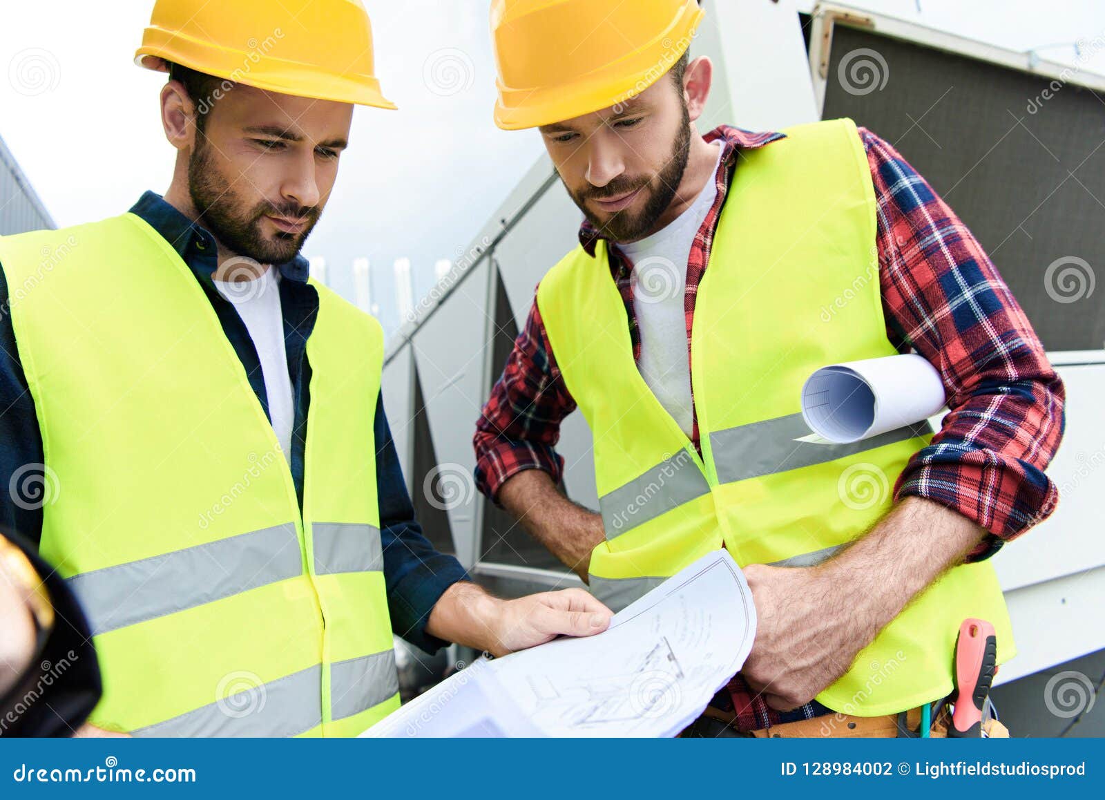 Two Architects in Safety Vests and Helmets Looking Stock Photo - Image ...