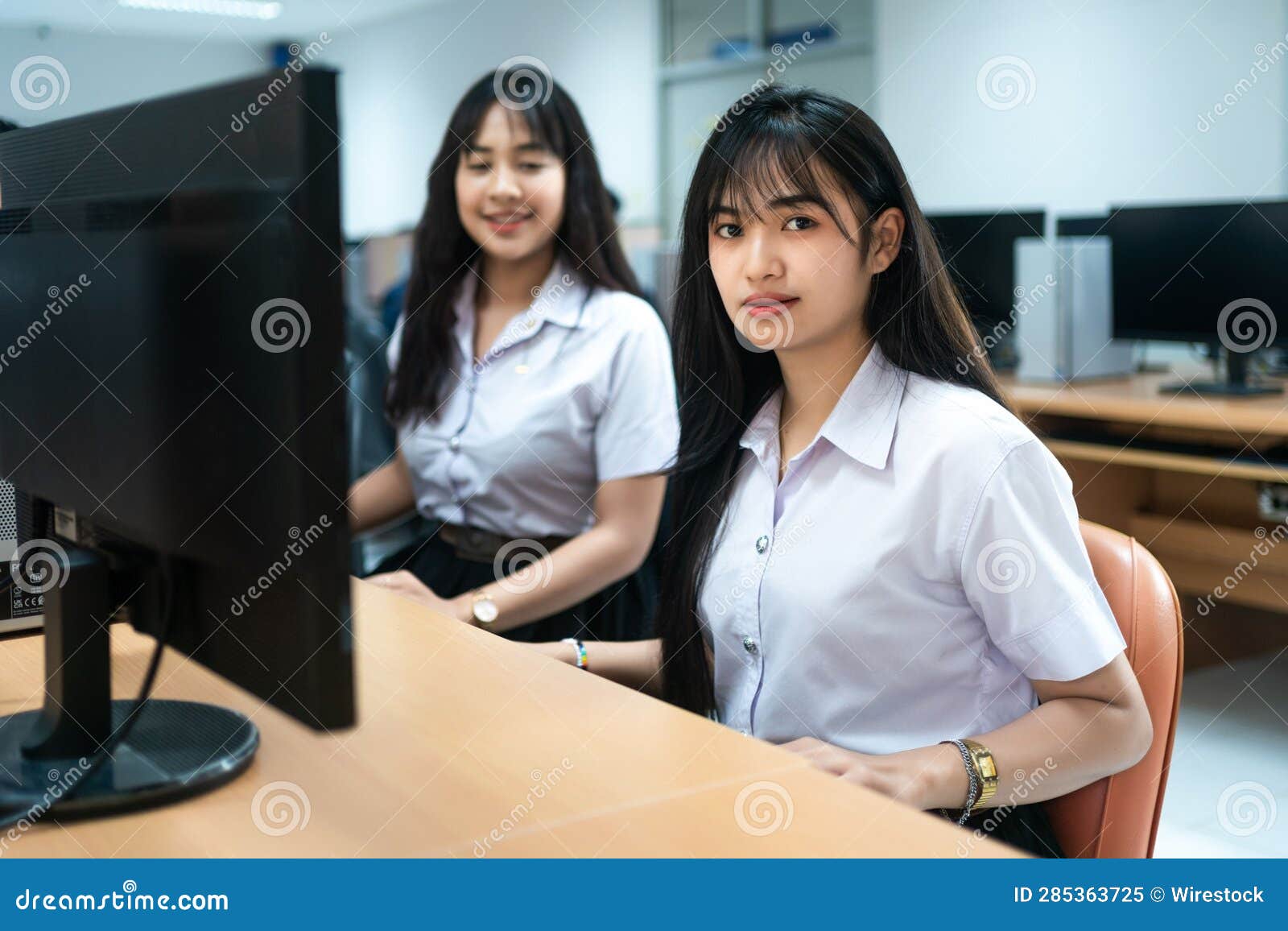 Asian Female Students Sitting Side by Side in Front of a Computer Stock ...