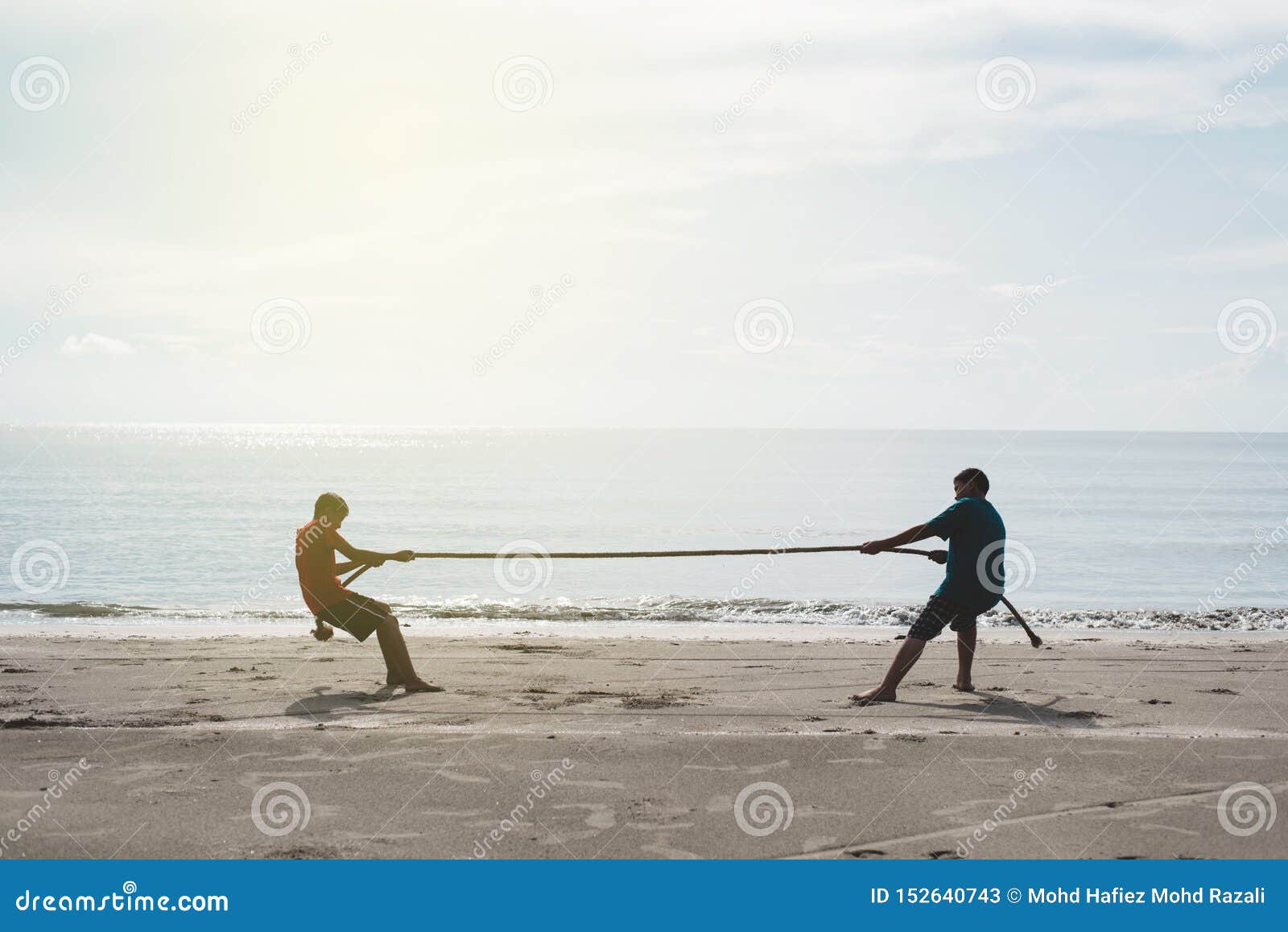 Two Asian Kids Pulling a Rope at the Beach Stock Image - Image of ...