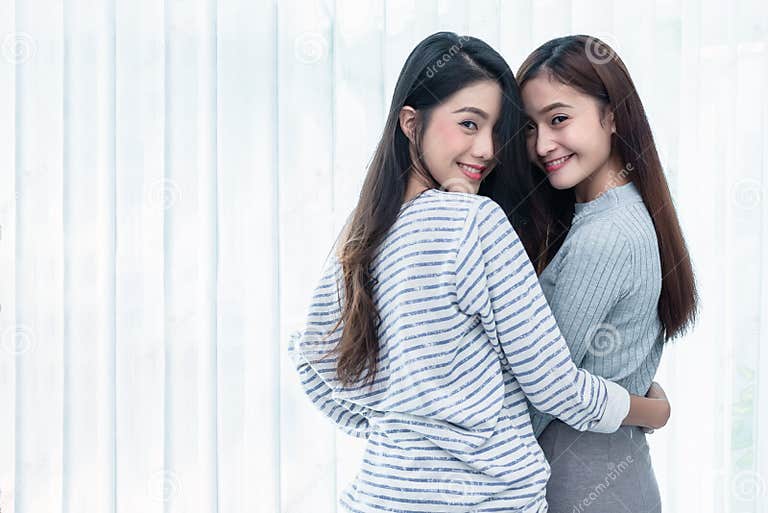 Two Asian Lesbian Women Looking Together In Bedroom Couple People And