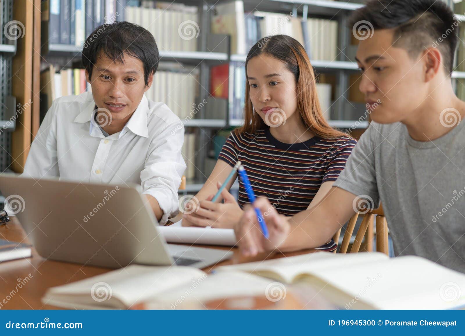 Two Asian Students Researching for Project in Library Stock Photo ...