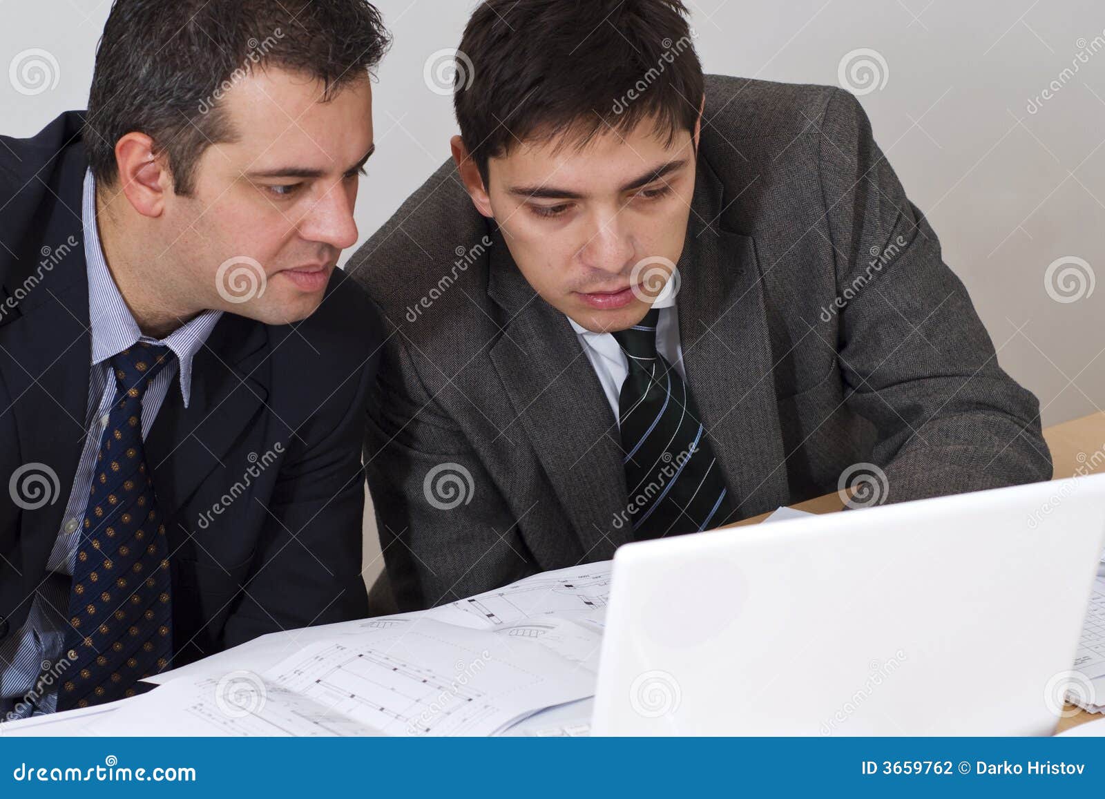 Two associates on a laptop stock photo. Image of modern - 3659762