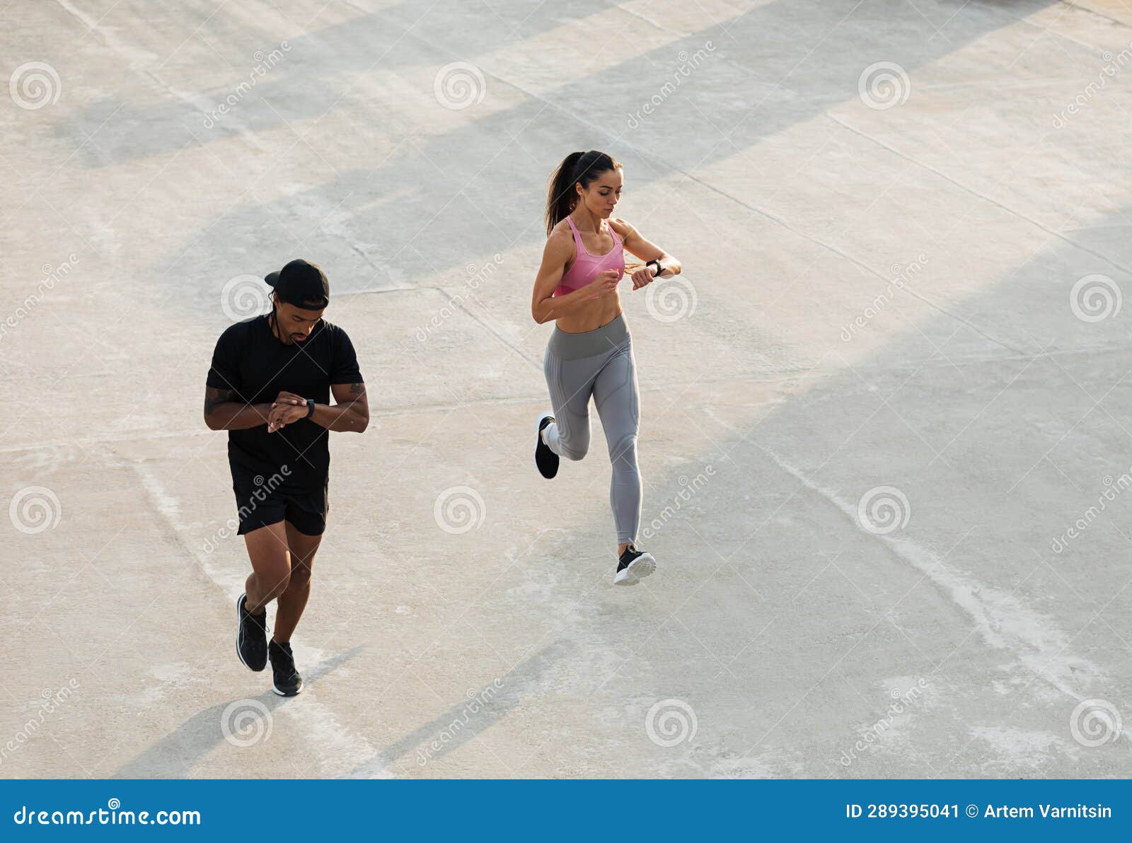 Two Athletes Checking Their Smartwatches Stock Image - Image of ...