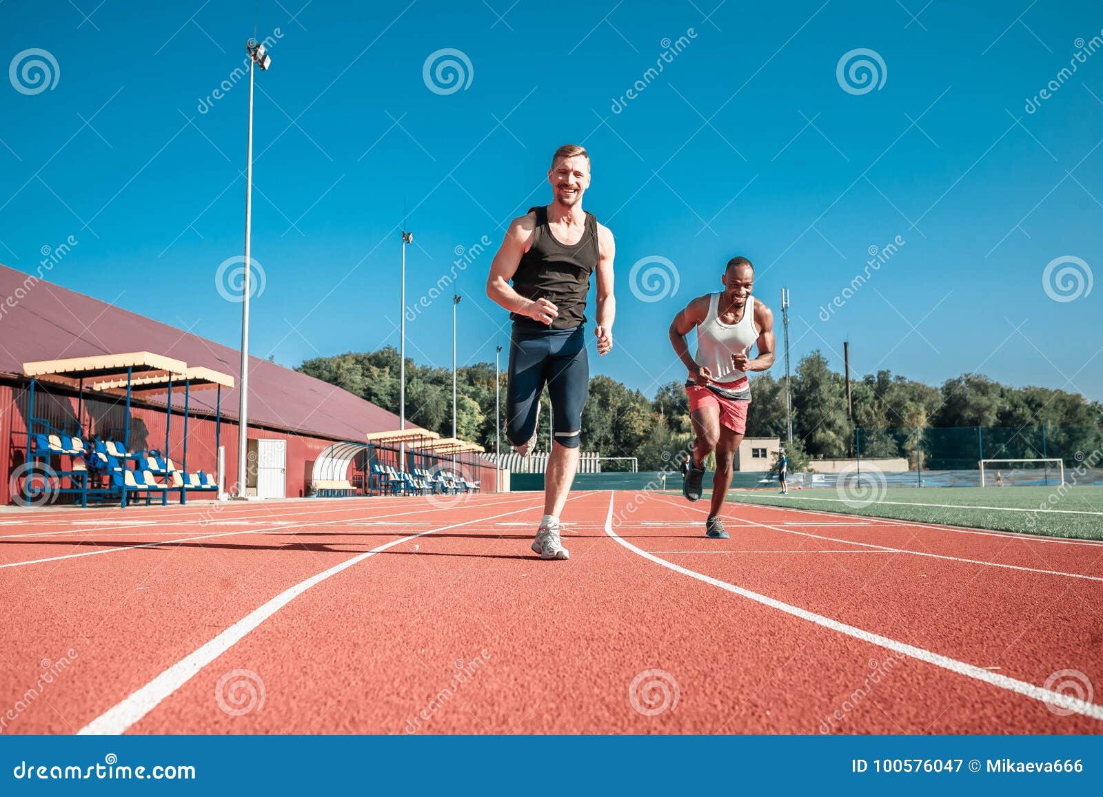 Two Athletes Finish Cheerfully Stock Image - Image of field, african ...