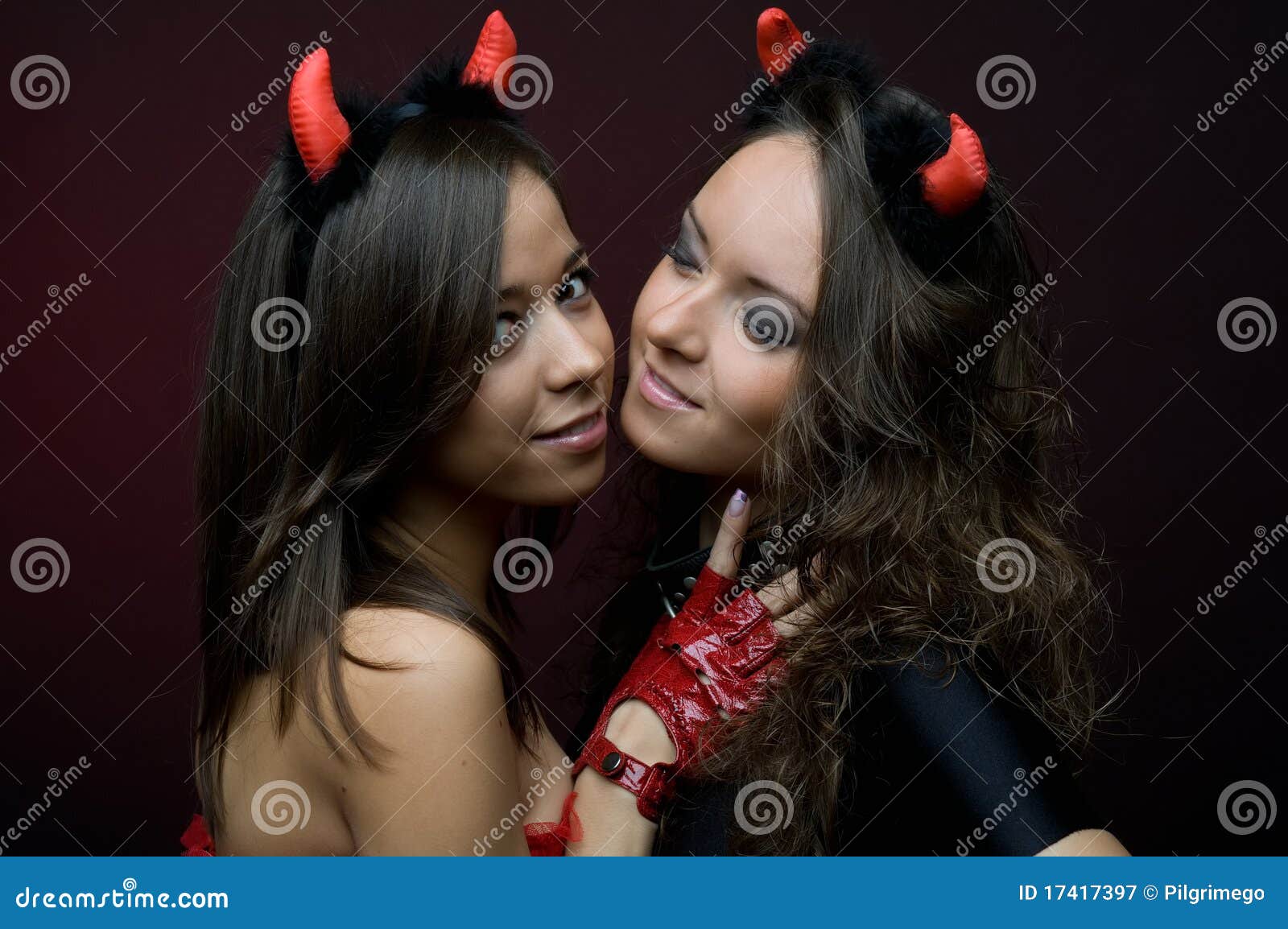 Two attractive devils stock image. Image of flirting - 17417397