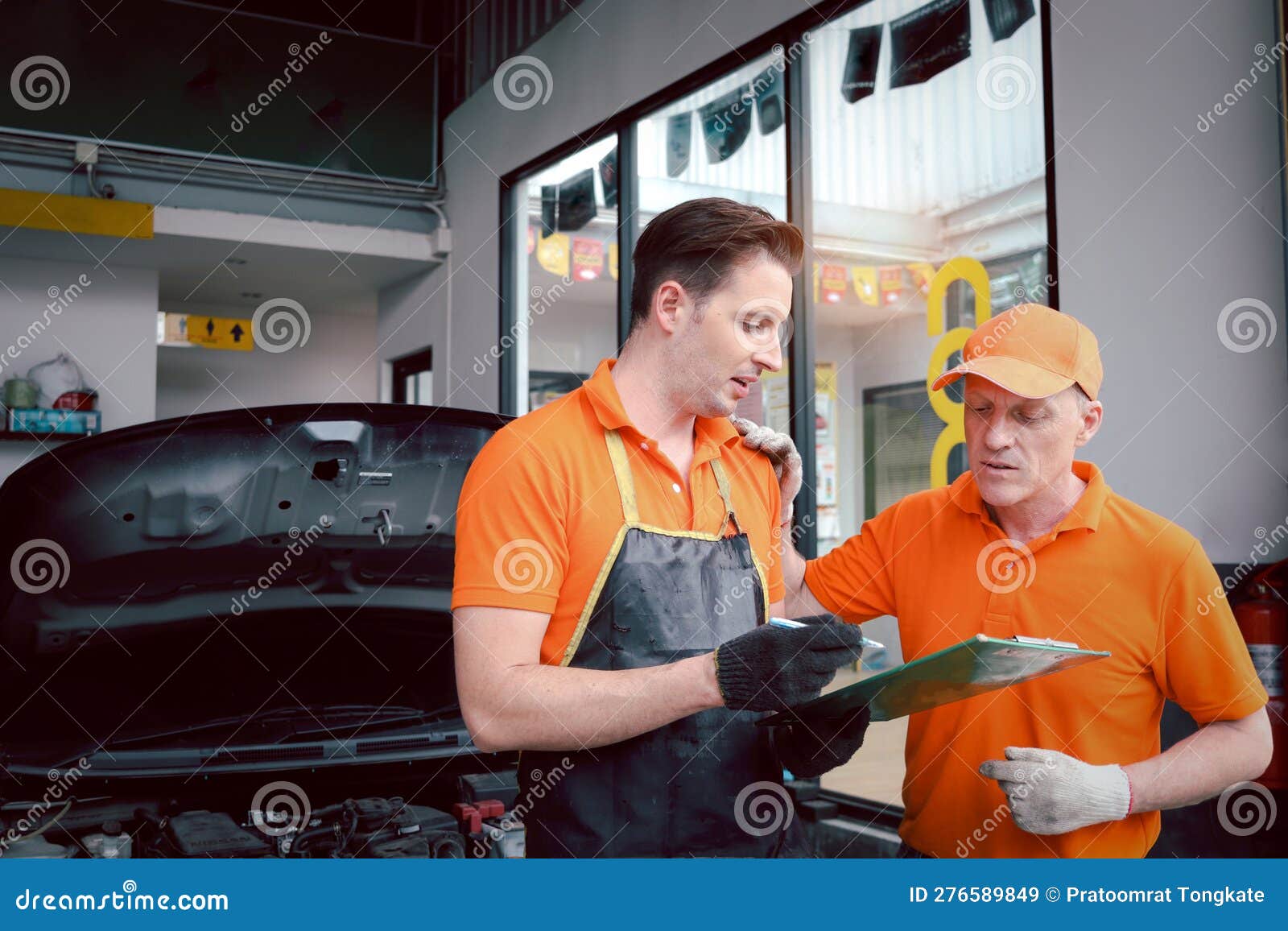 Two Auto Mechanic Worker Men Working with Engine in Garage, Senior and ...