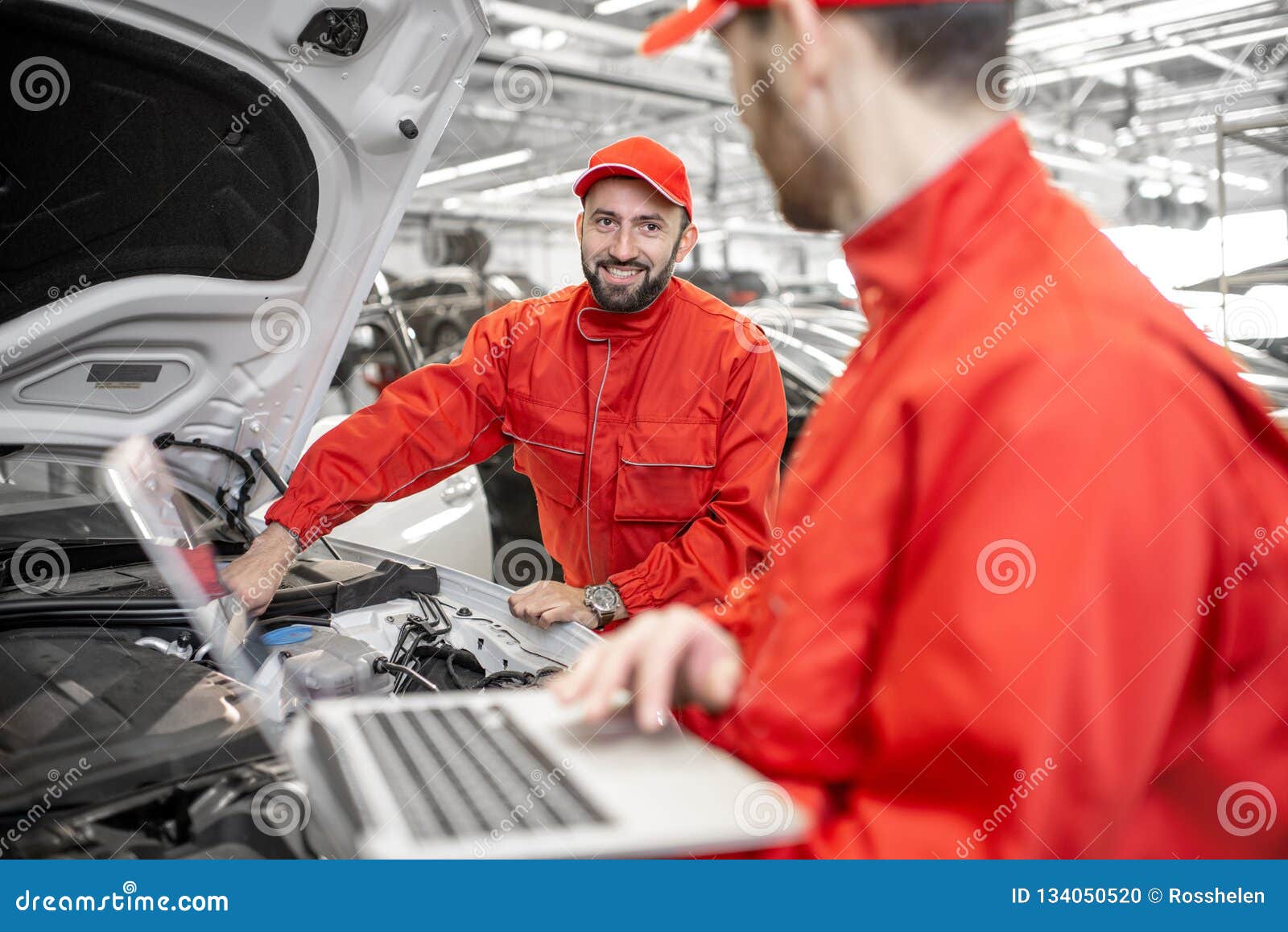 Auto Mechanics Doing Diagnostics with Laptop Stock Photo - Image of ...