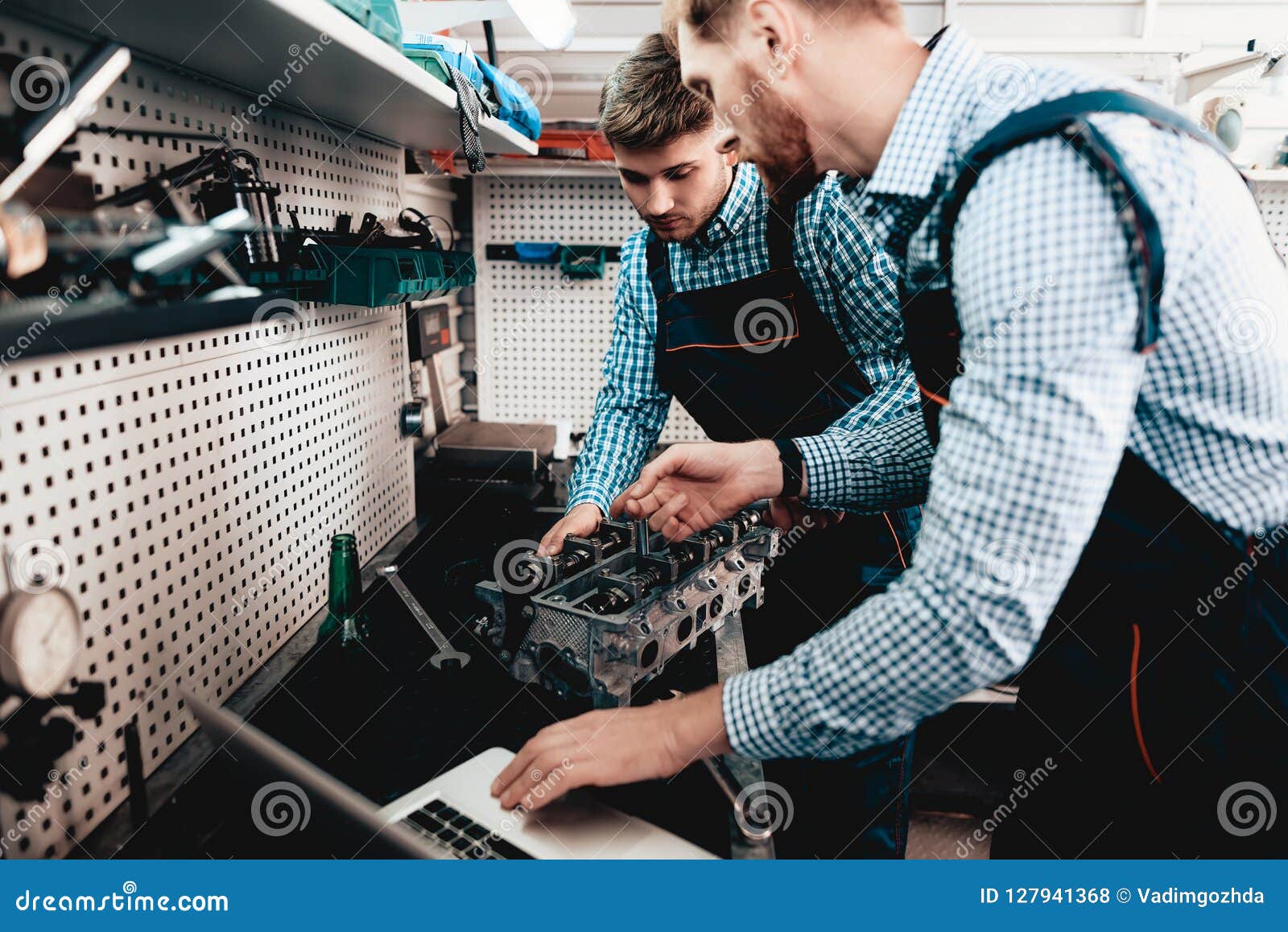 Two Mechanics Work Together on Service Station. Stock Photo - Image of ...