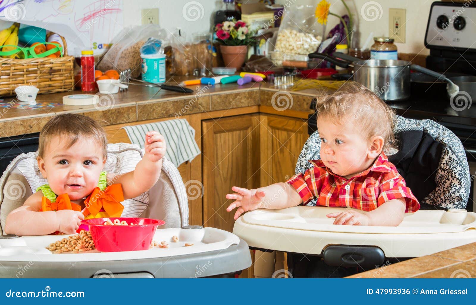 Two Babies Eat Breakfast stock photo. Image of messy - 47993936