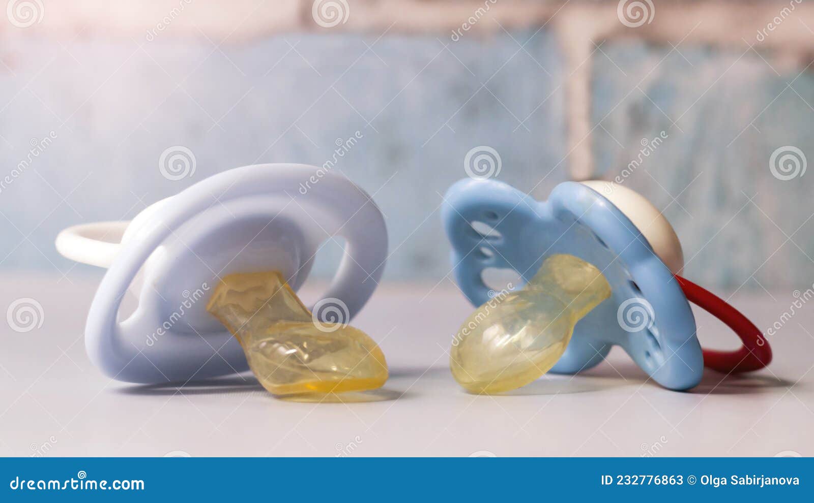 Two Baby Pacifiers on a Blue Background Stock Image - Image of close ...