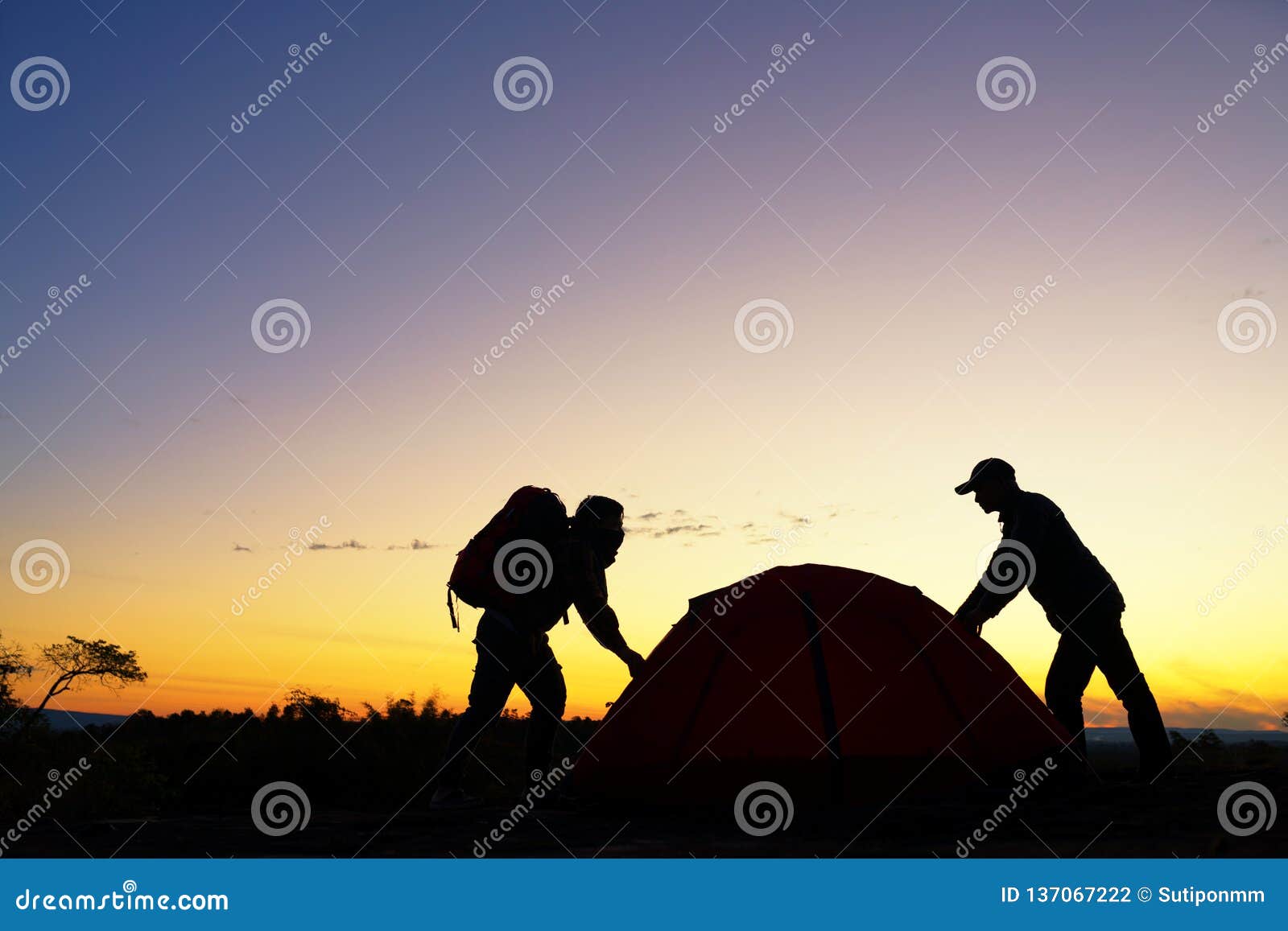 Two Backpacker Help Hold Tent in Camping Trip on the Hill Stock Photo ...