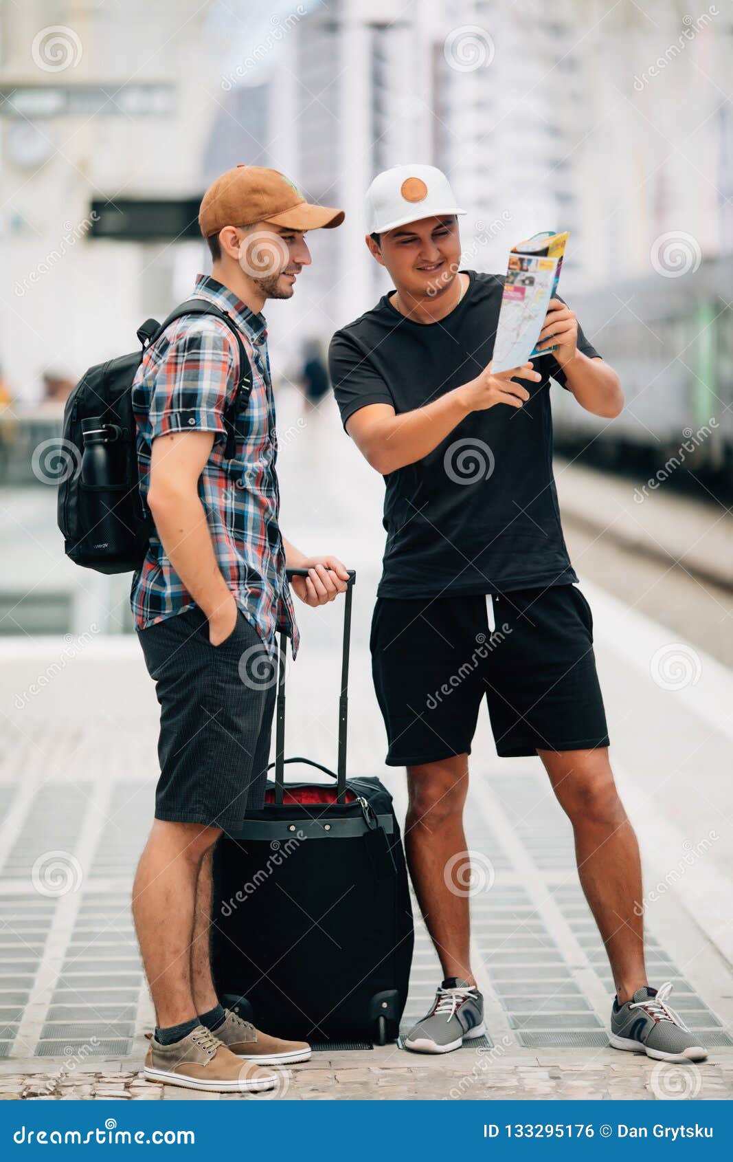 Two Backpackers Look at a Map at Train Station. Travel Concept Stock ...