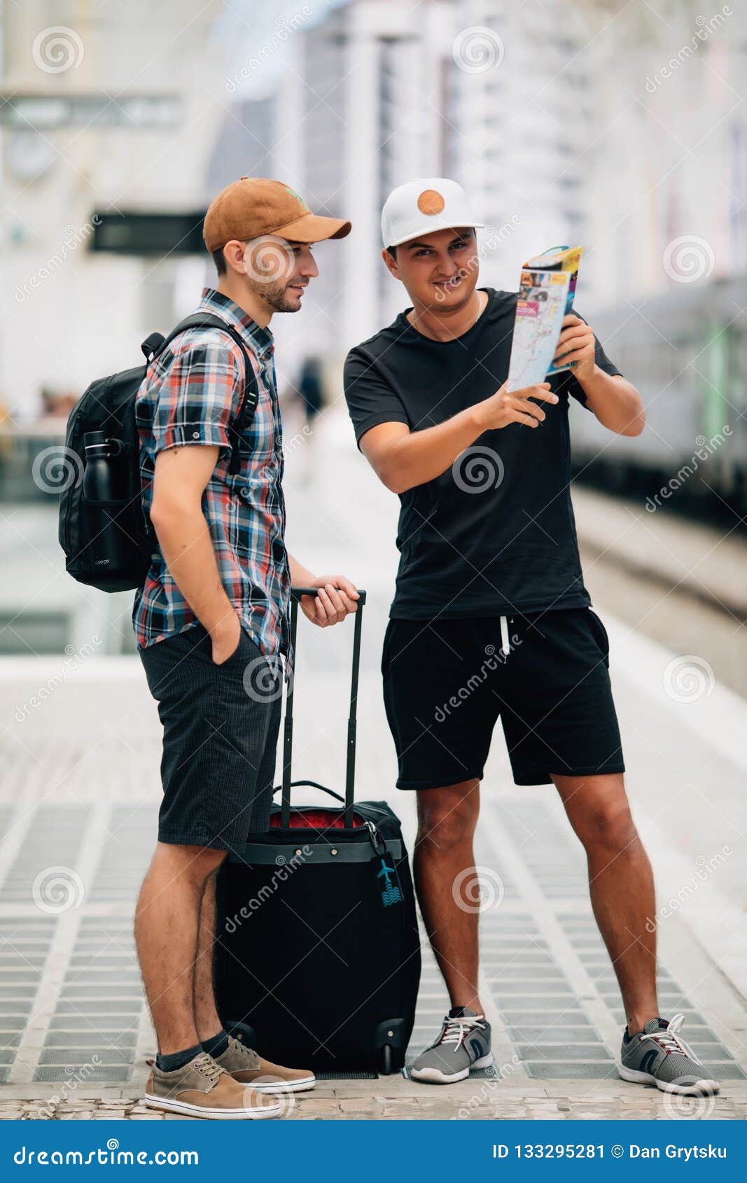 Two Backpackers Look at a Map at Train Station. Travel Concept Stock ...
